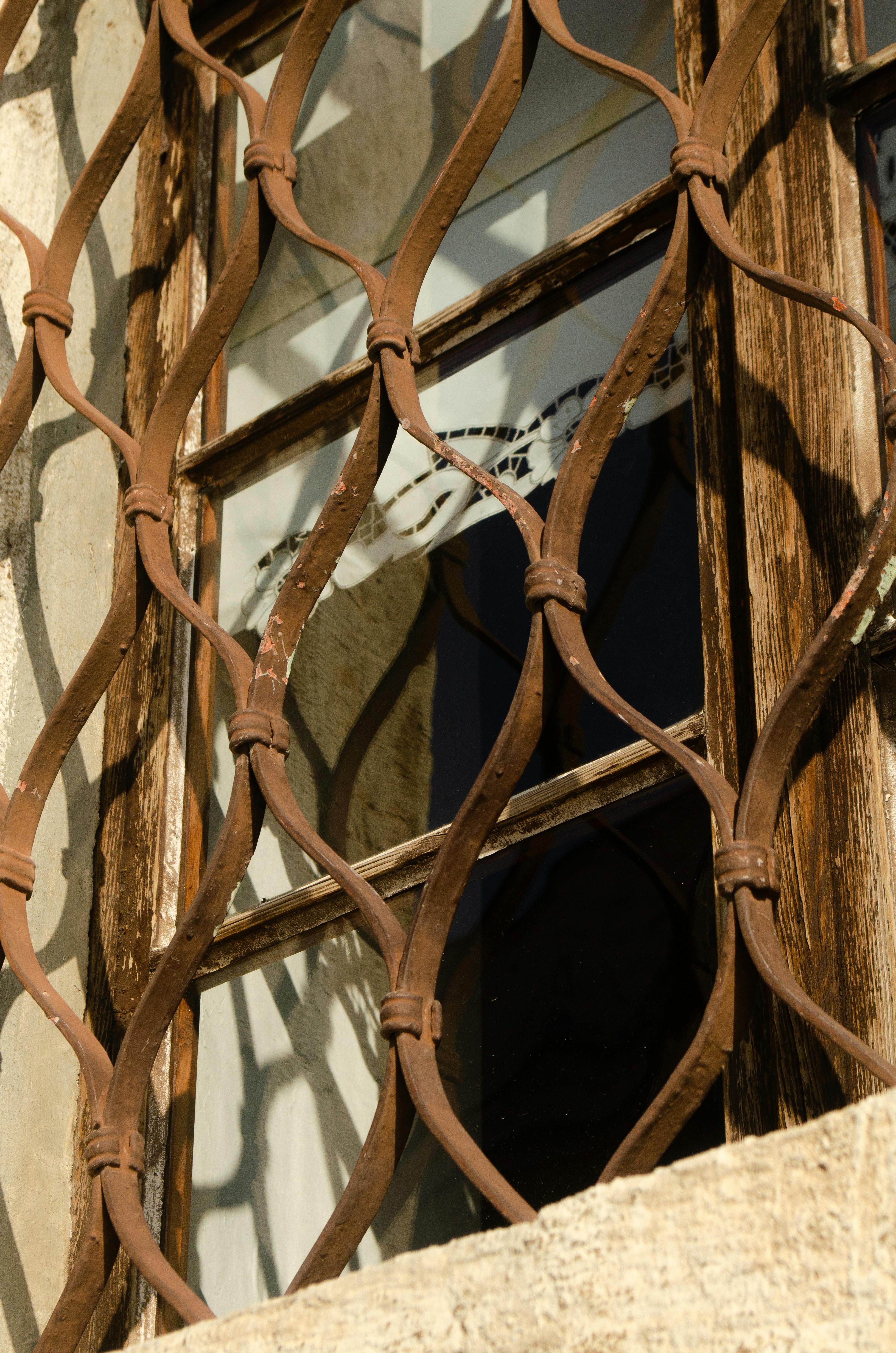 Rustic Barred Window with Sunlit Shadows · Free Stock Photo