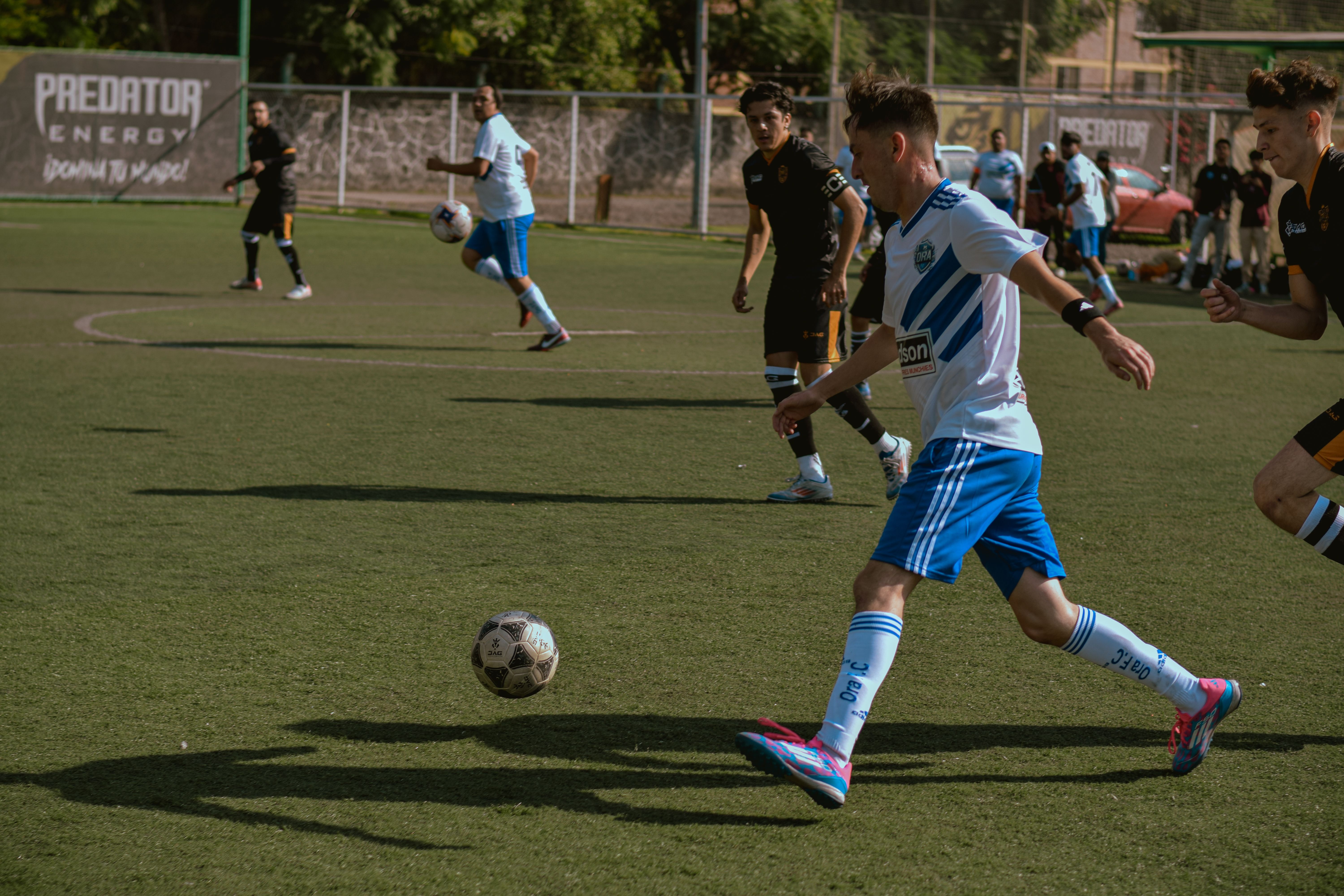 Intense Soccer Match Action on Green Field · Free Stock Photo
