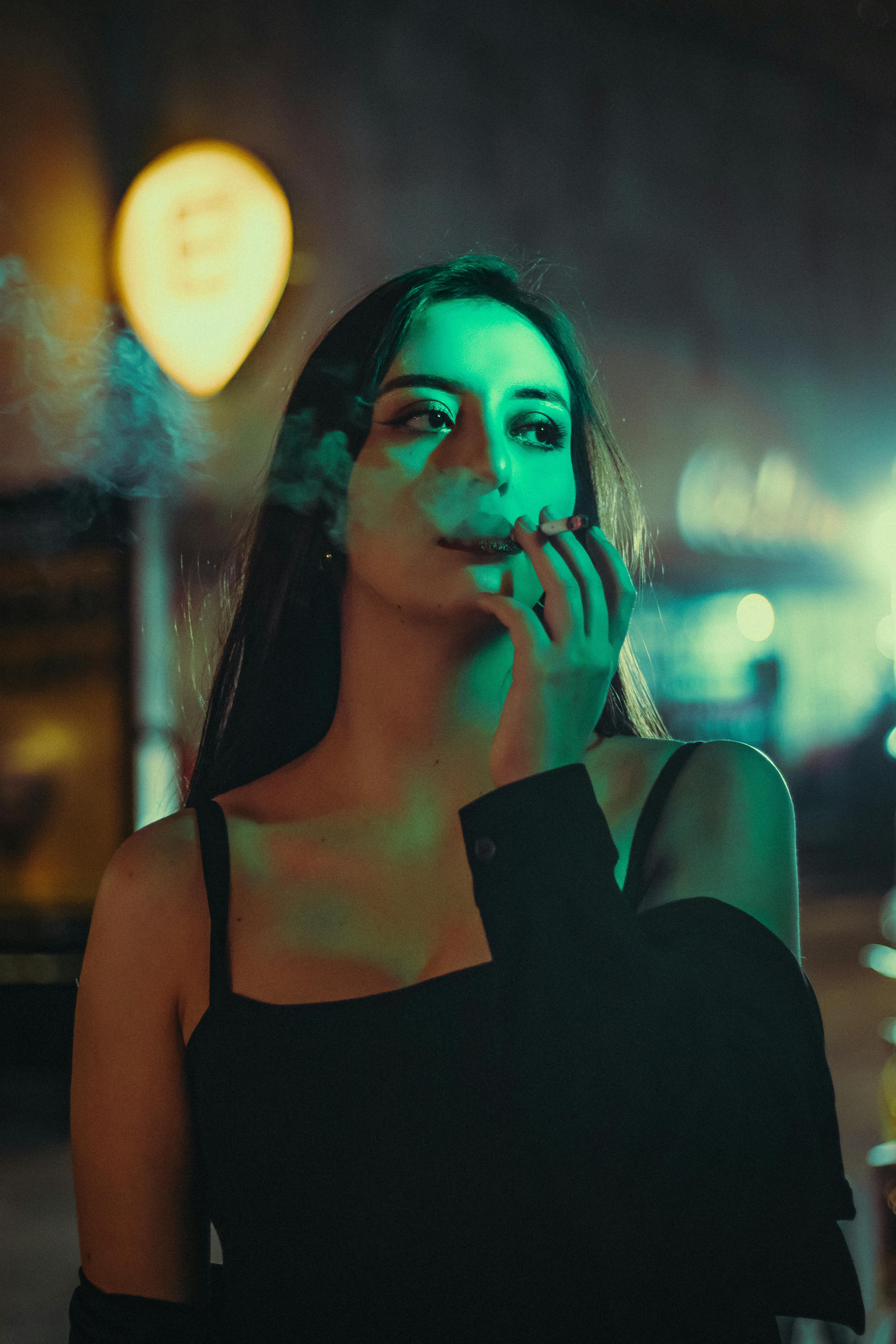 Young Woman Smoking in Urban Night Scene · Free Stock Photo