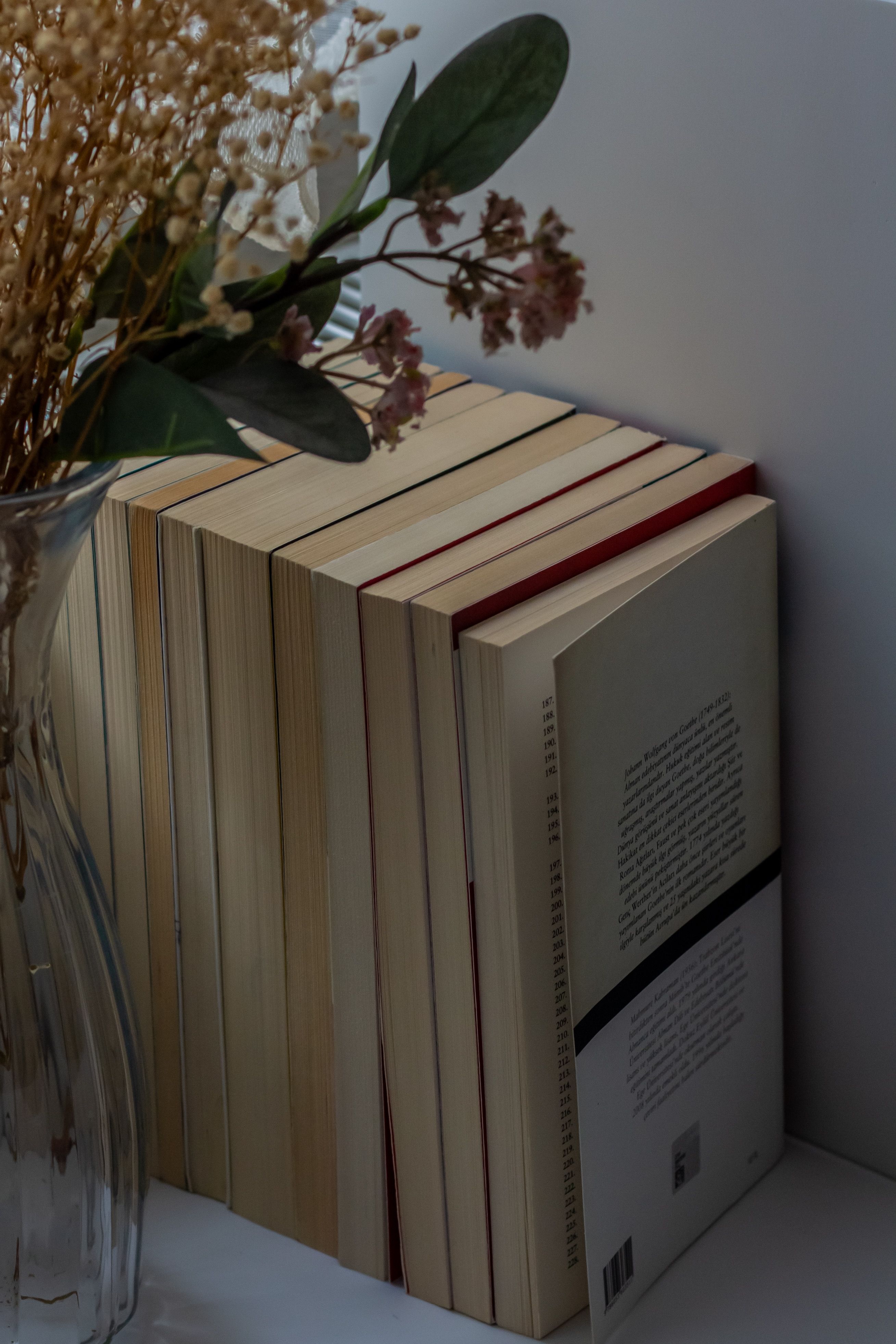 Elegant Book Stack with Floral Arrangement · Free Stock Photo