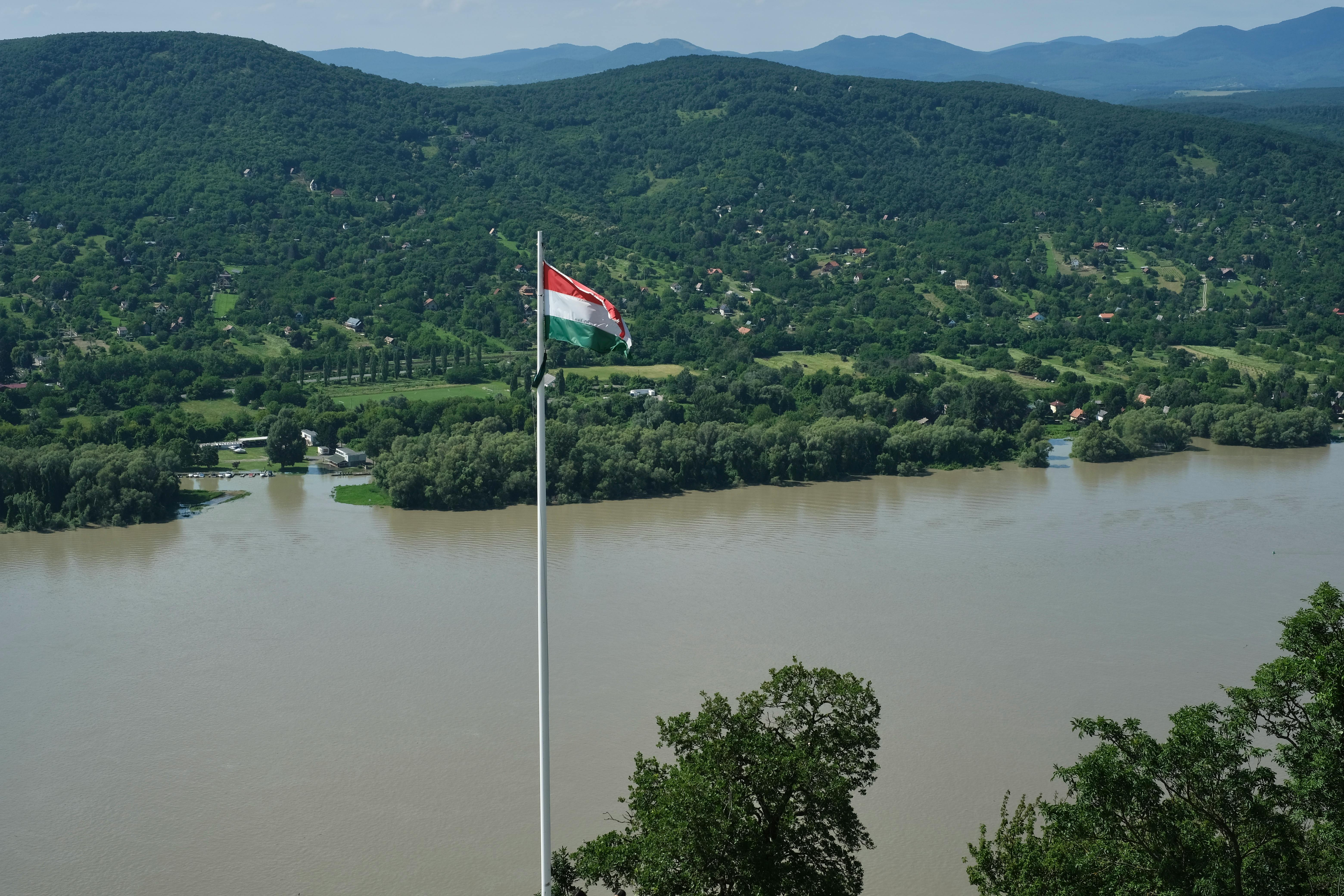 Hungarian Flag Over Danube River Scenic View · Free Stock Photo