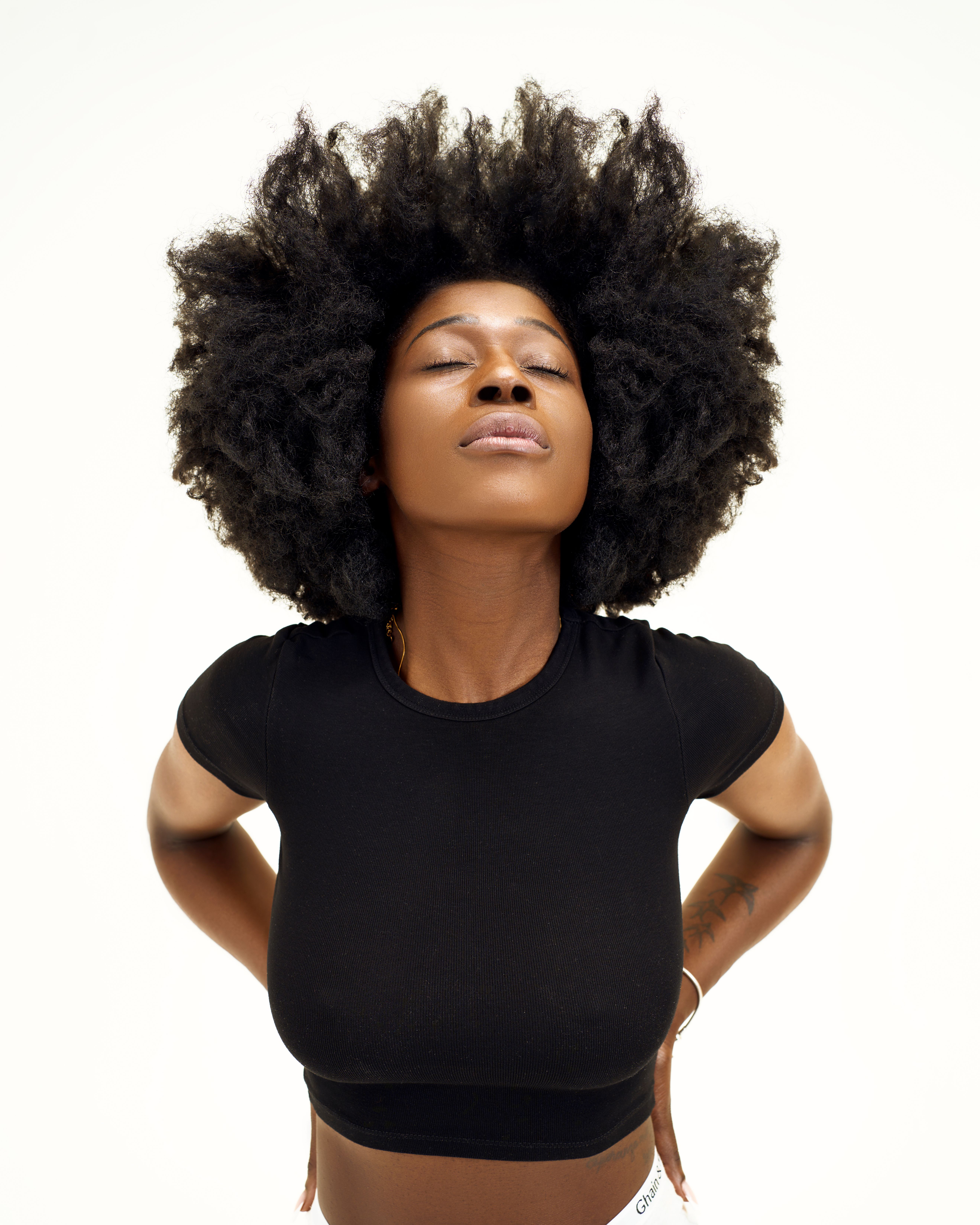 Confident Woman with Natural Afro Hairstyle · Free Stock Photo