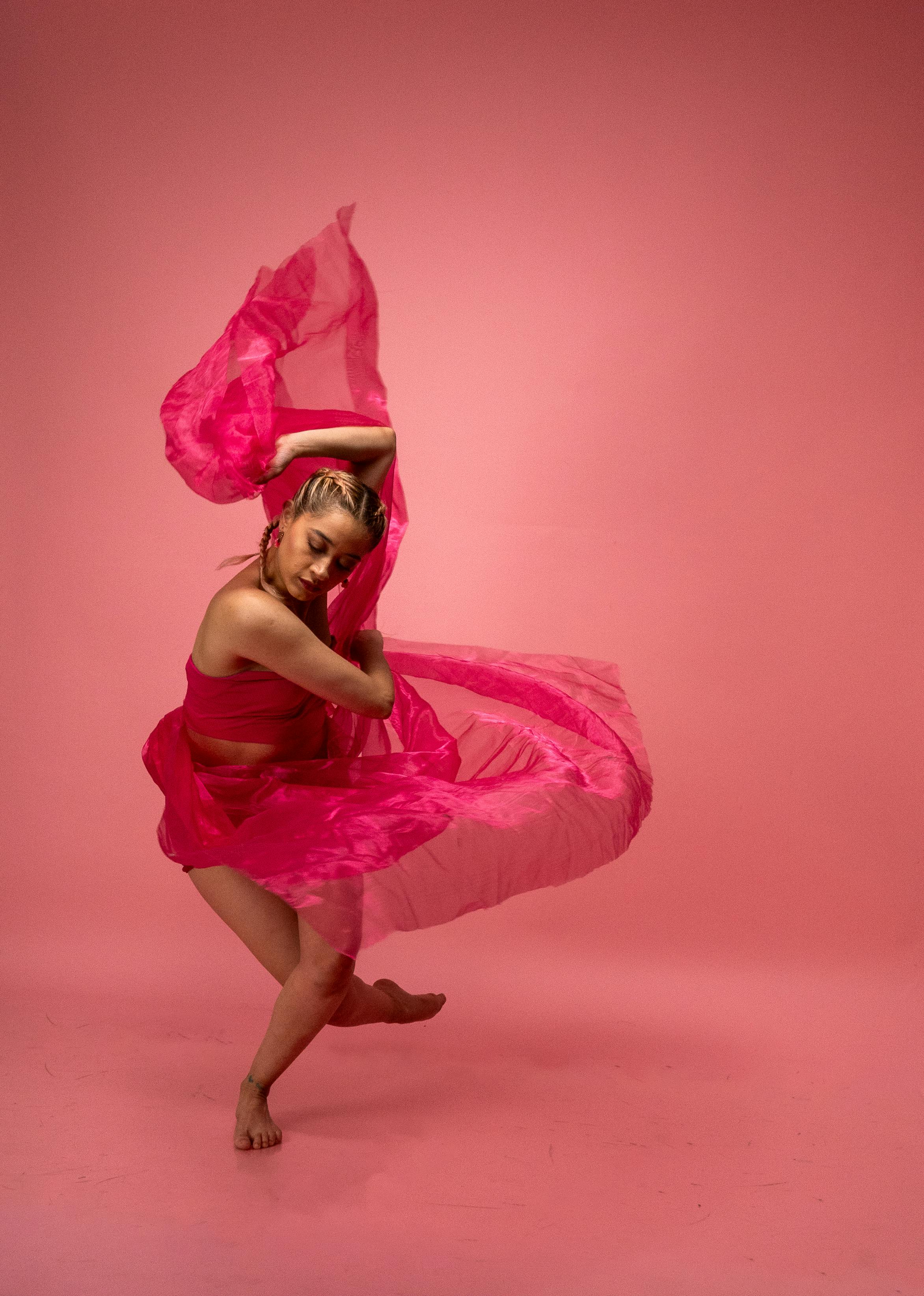 Graceful Female Dancer in Vibrant Pink Flowing Costume · Free Stock Photo