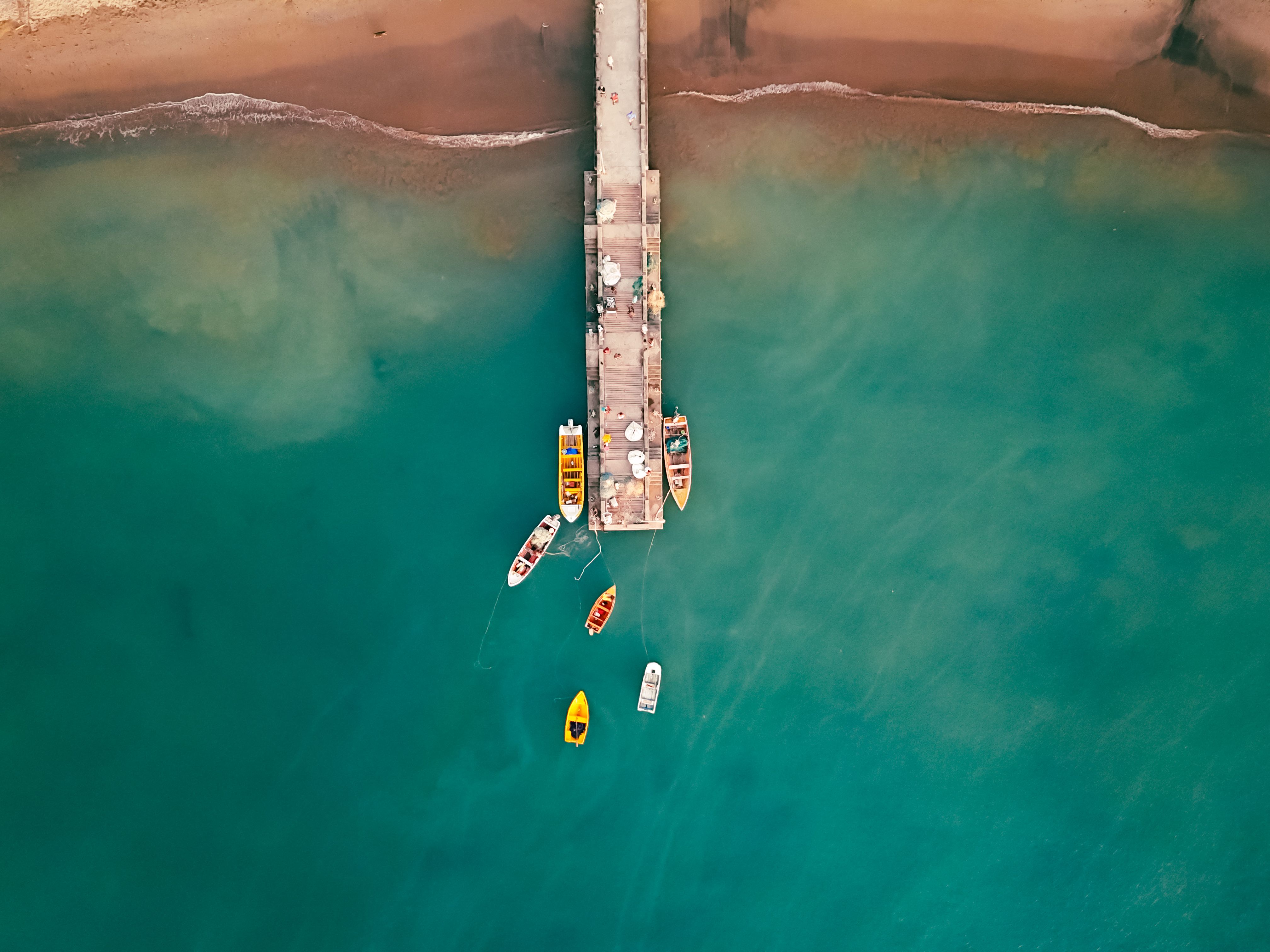 Aerial view of dock with colorful boats on turquoise water · Free Stock ...