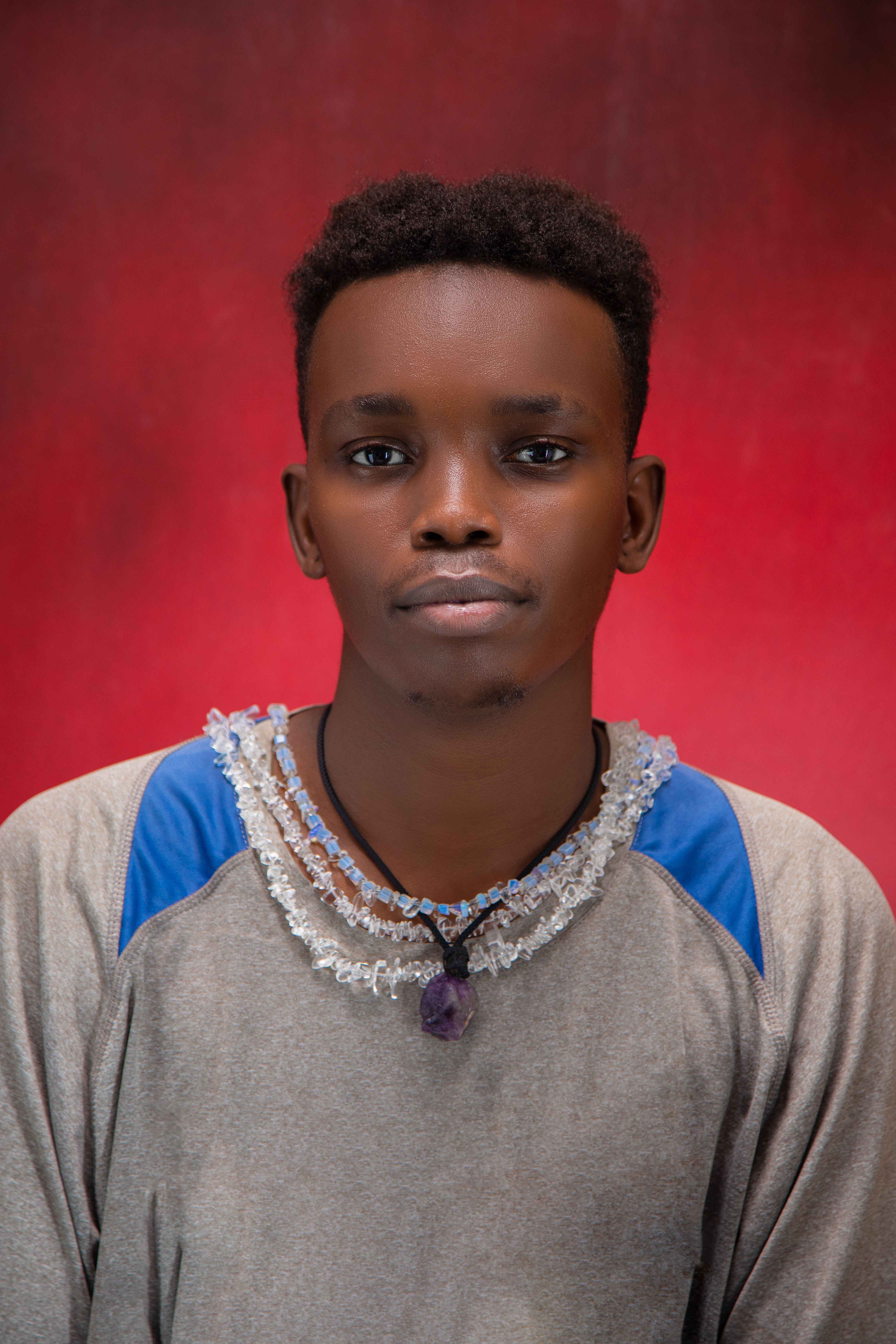 Portrait of a Young Man with a Red Background · Free Stock Photo