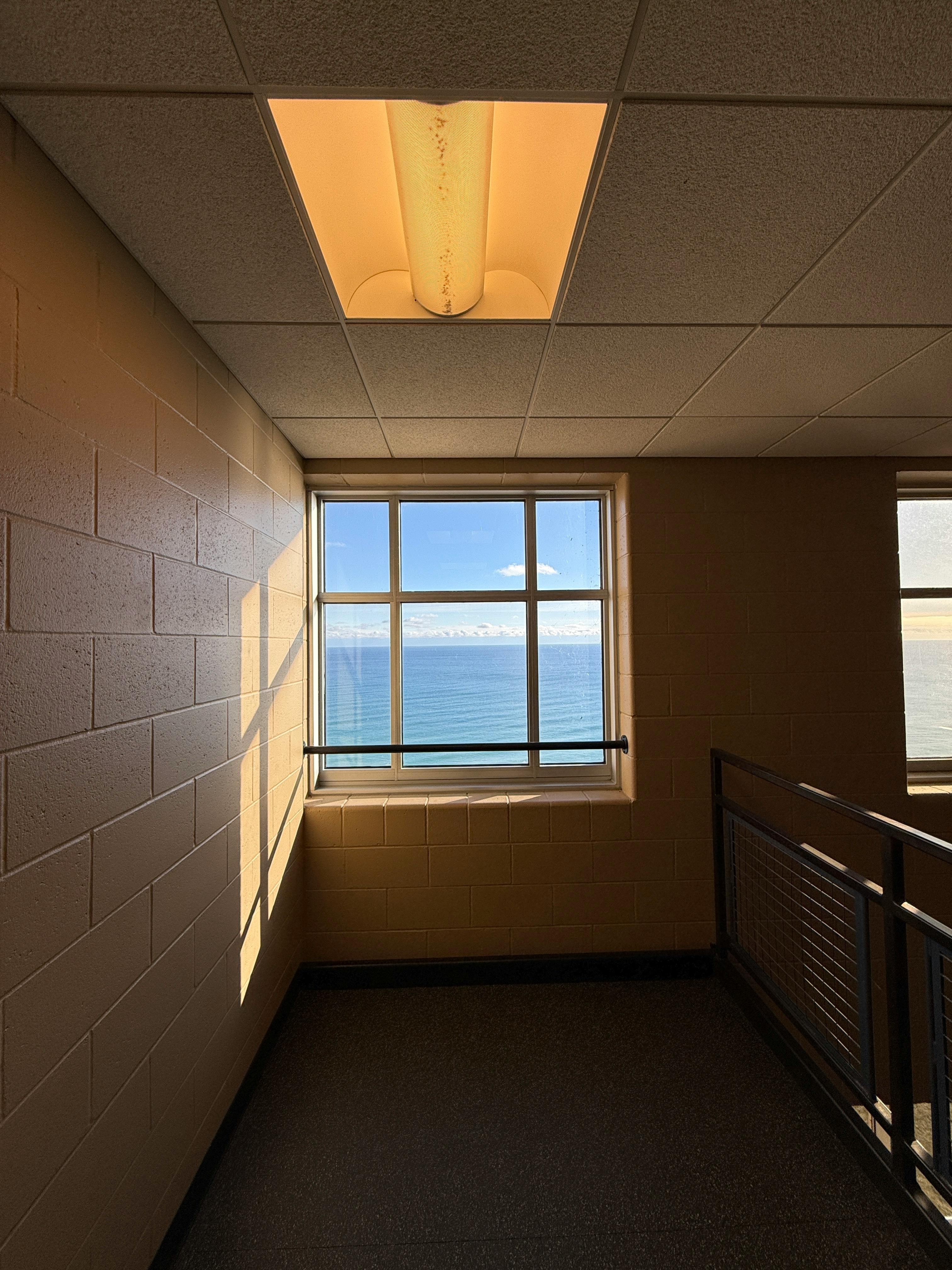 Sunny Ocean View from Indoor Hallway Window · Free Stock Photo