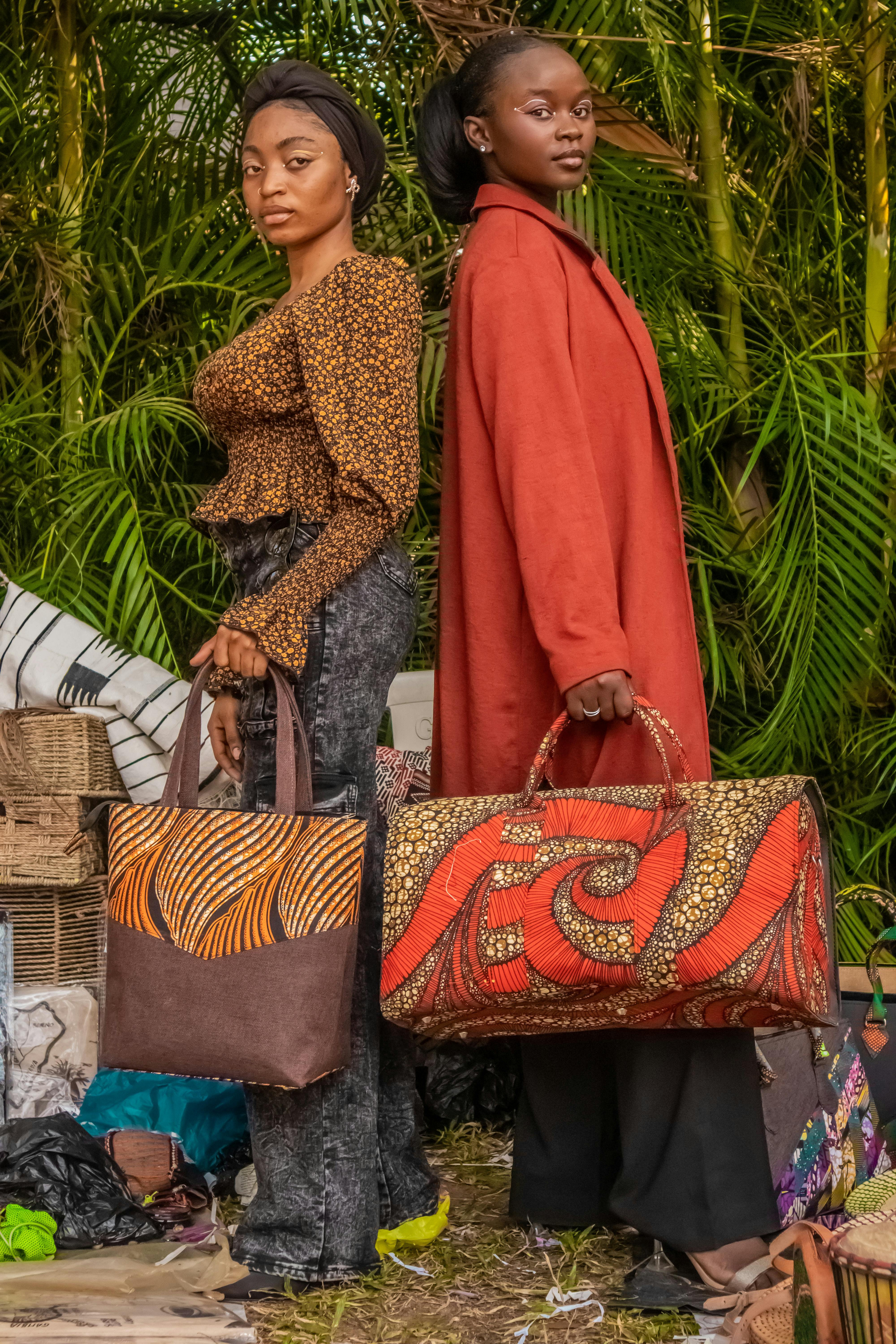 Elegant Women Displaying Vibrant African Bags · Free Stock Photo