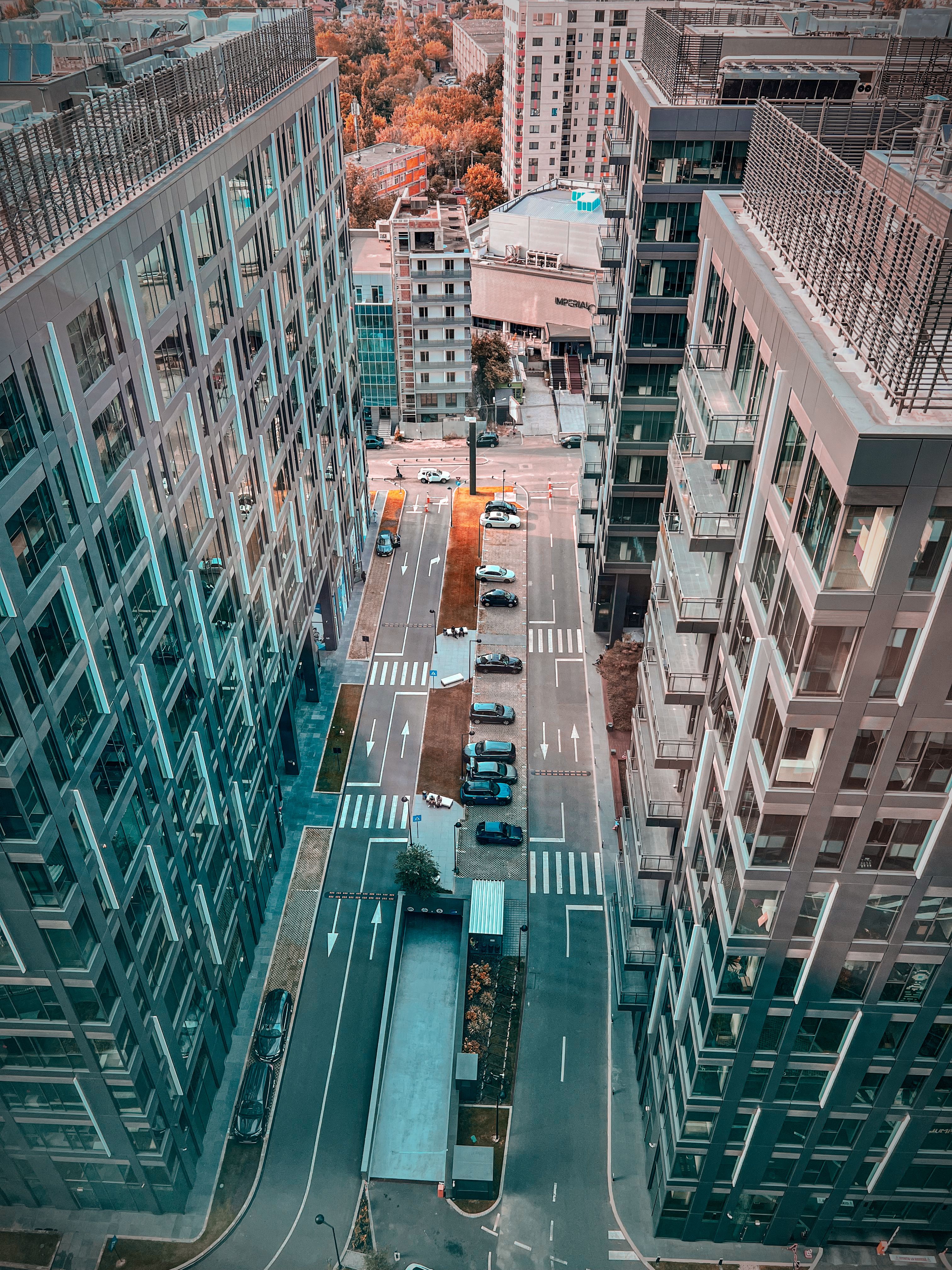 Aerial View of Urban Street Between Tall Buildings · Free Stock Photo