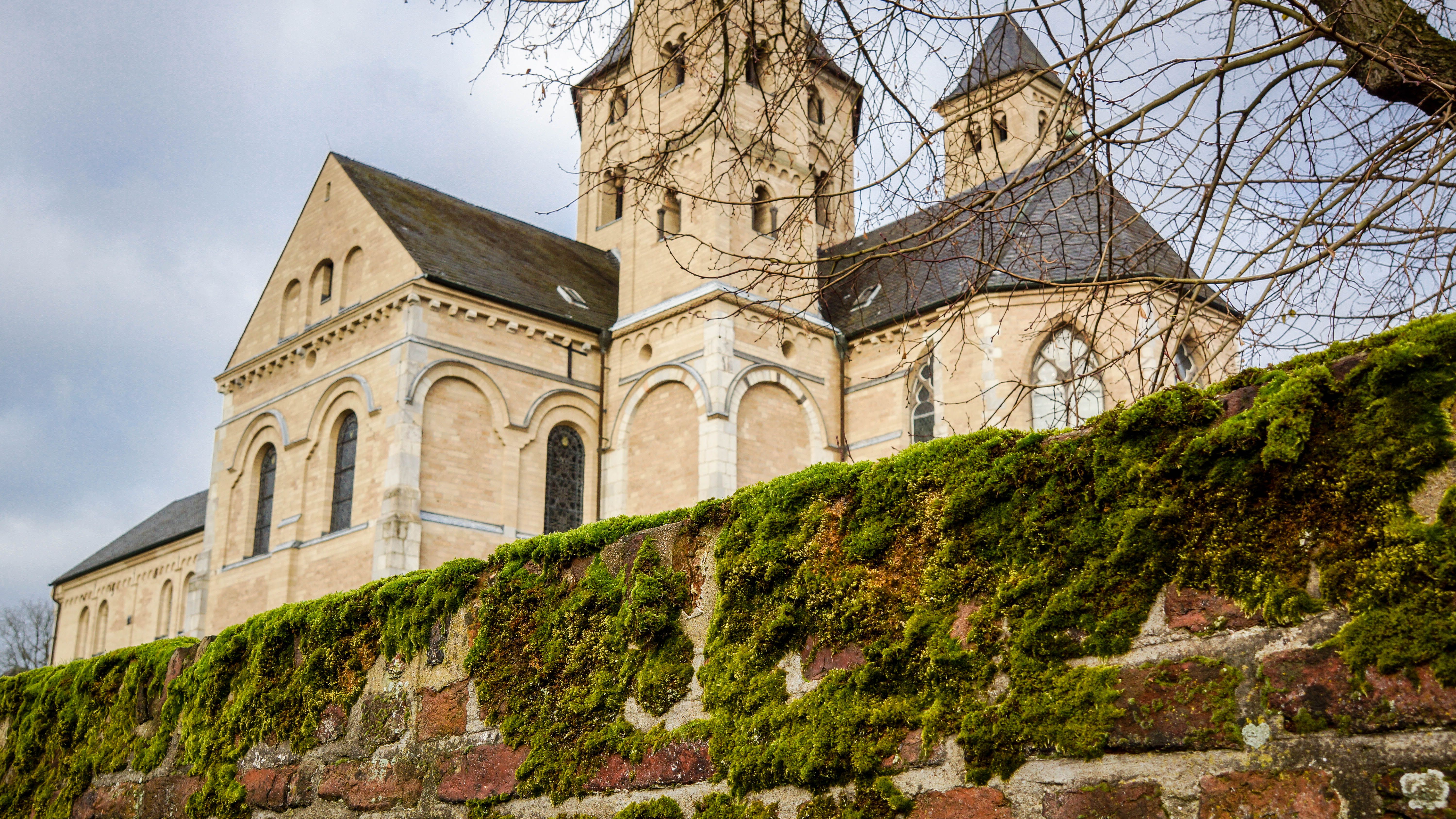 Historic European Church with Mossy Wall · Free Stock Photo