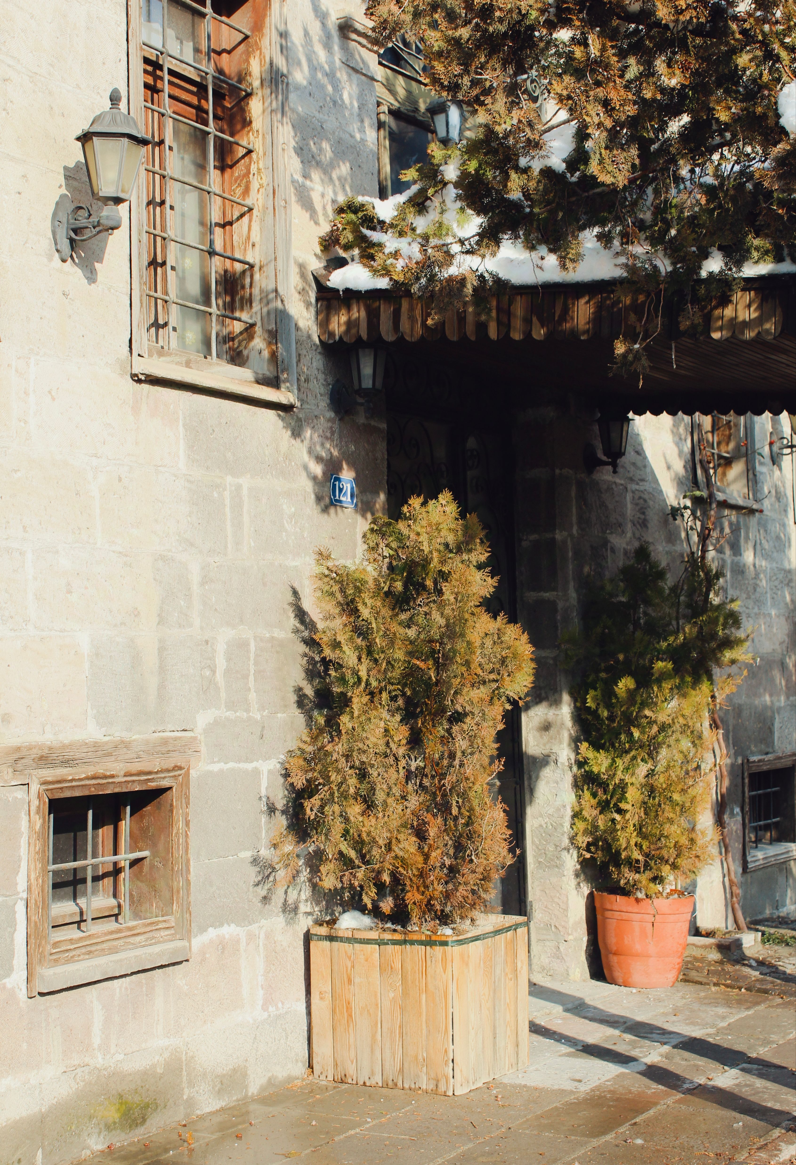 Rustic Stone Building with Potted Plants · Free Stock Photo