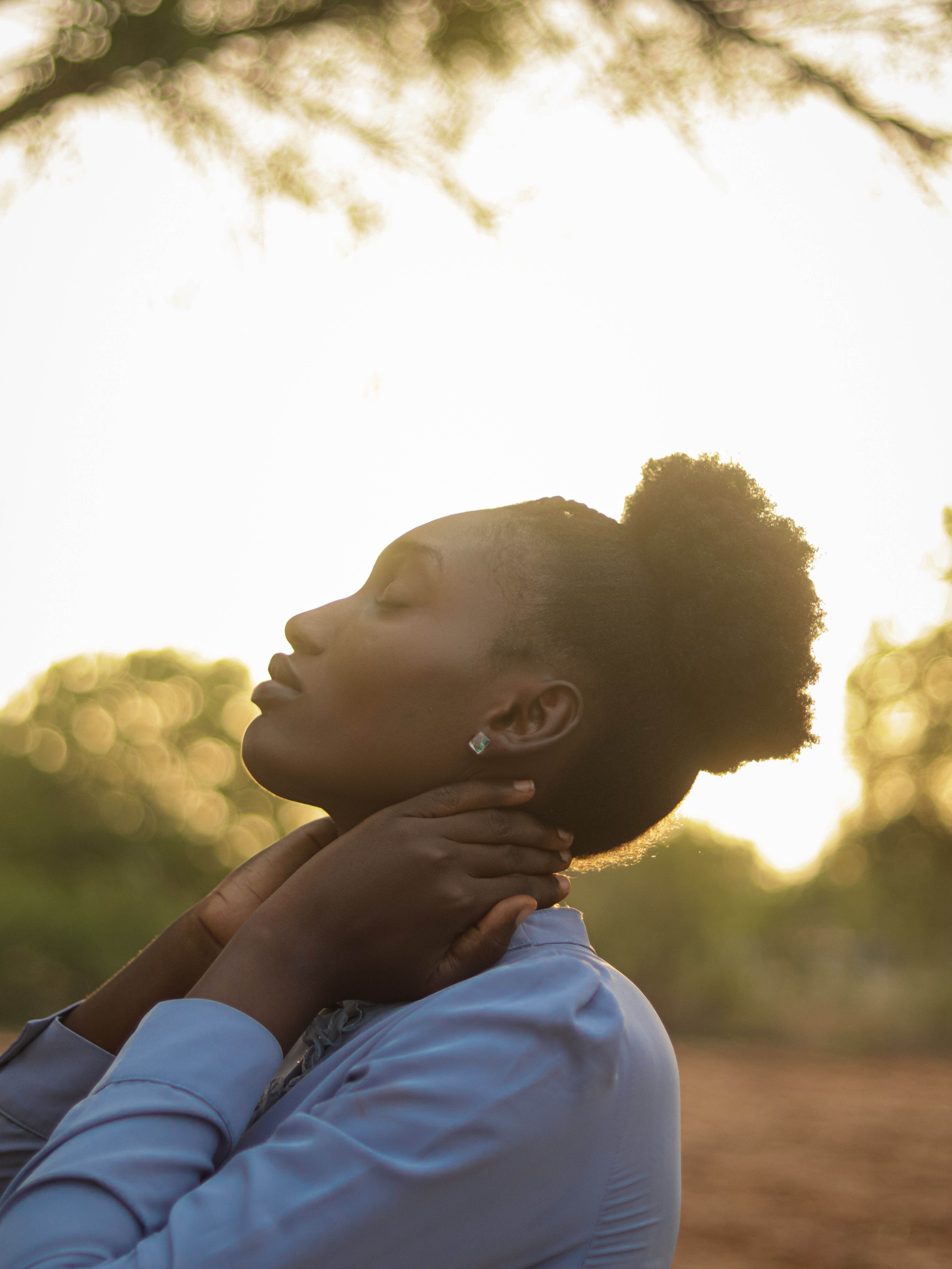 Peaceful Woman Posing in Natural Sunlight Outdoors · Free Stock Photo