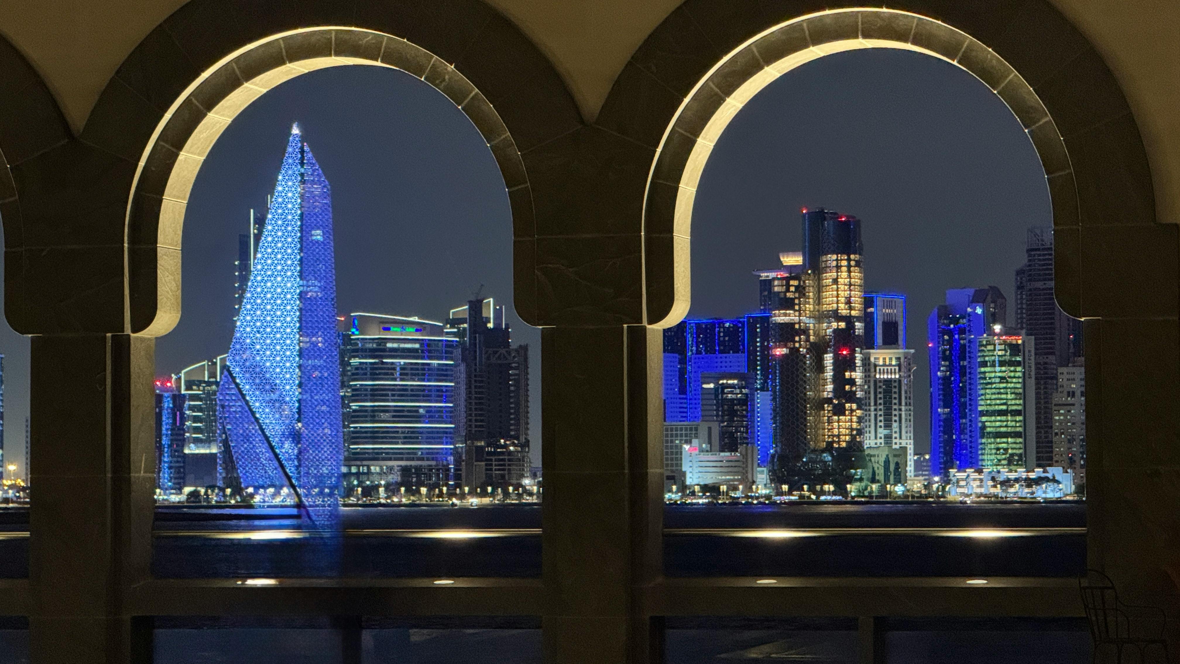 Doha Skyline Night View Through Archways · Free Stock Photo