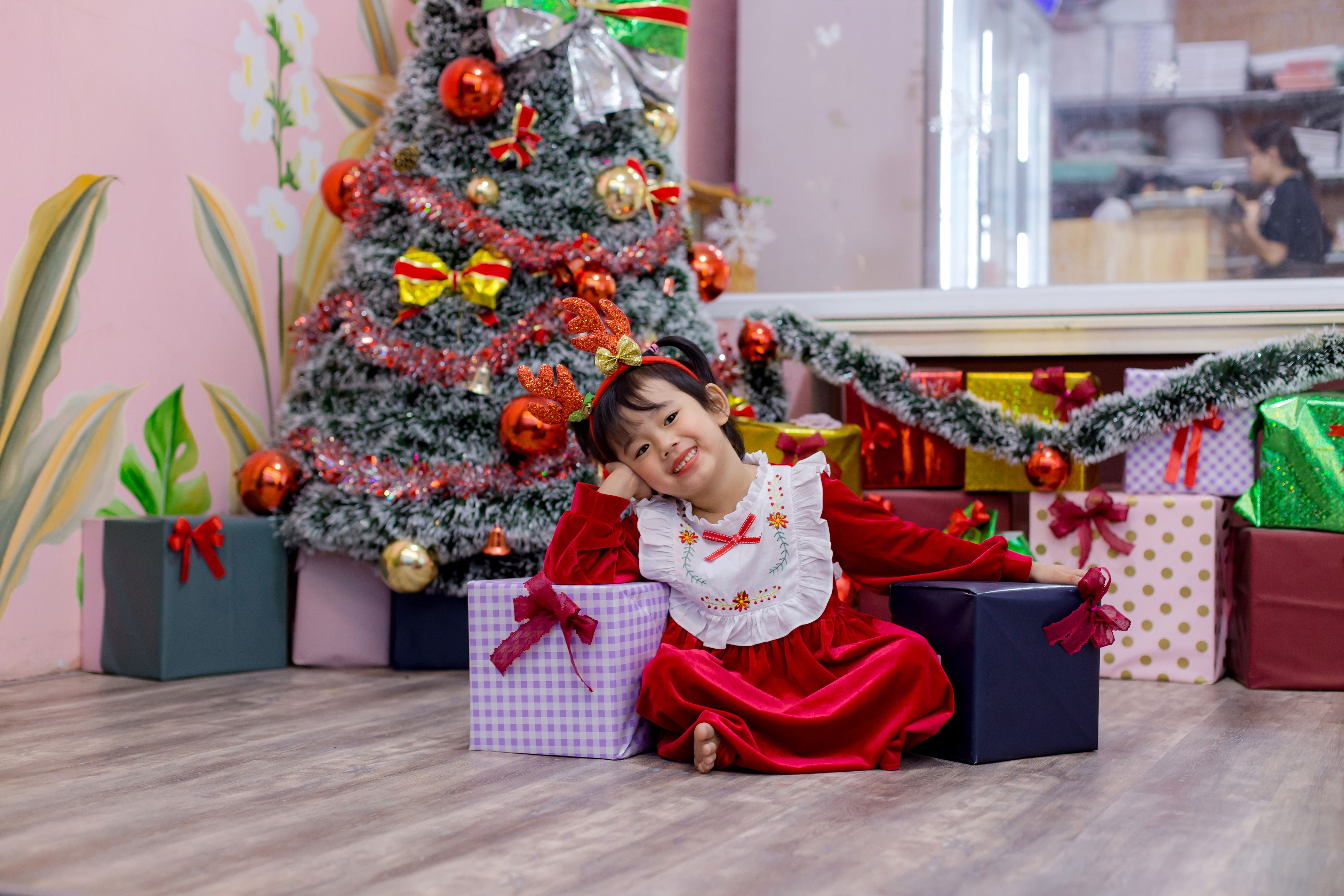 Festive Joy: Child Celebrating Christmas in Hội An · Free Stock Photo