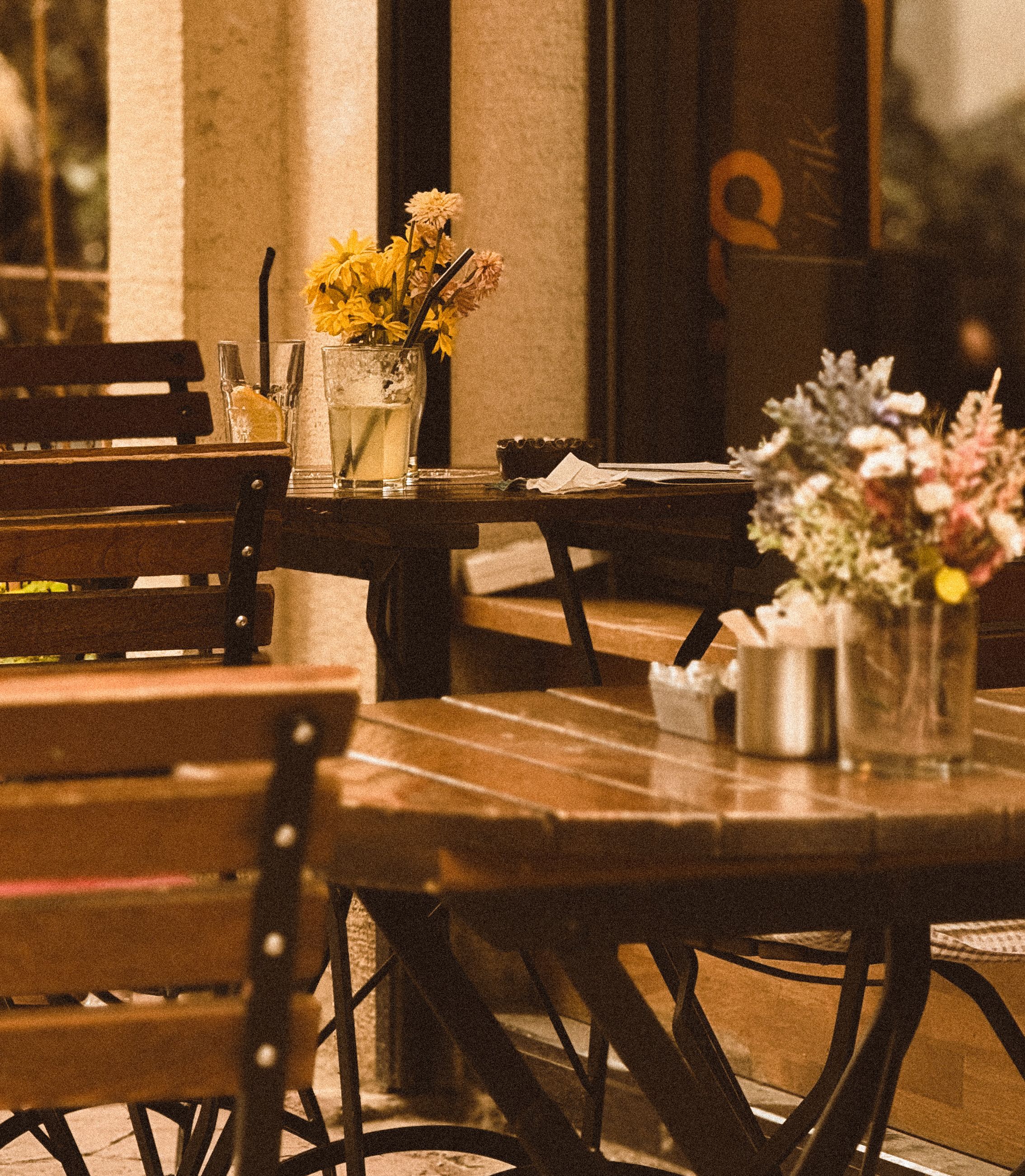 Cozy Outdoor Cafe Setting with Flowers · Free Stock Photo