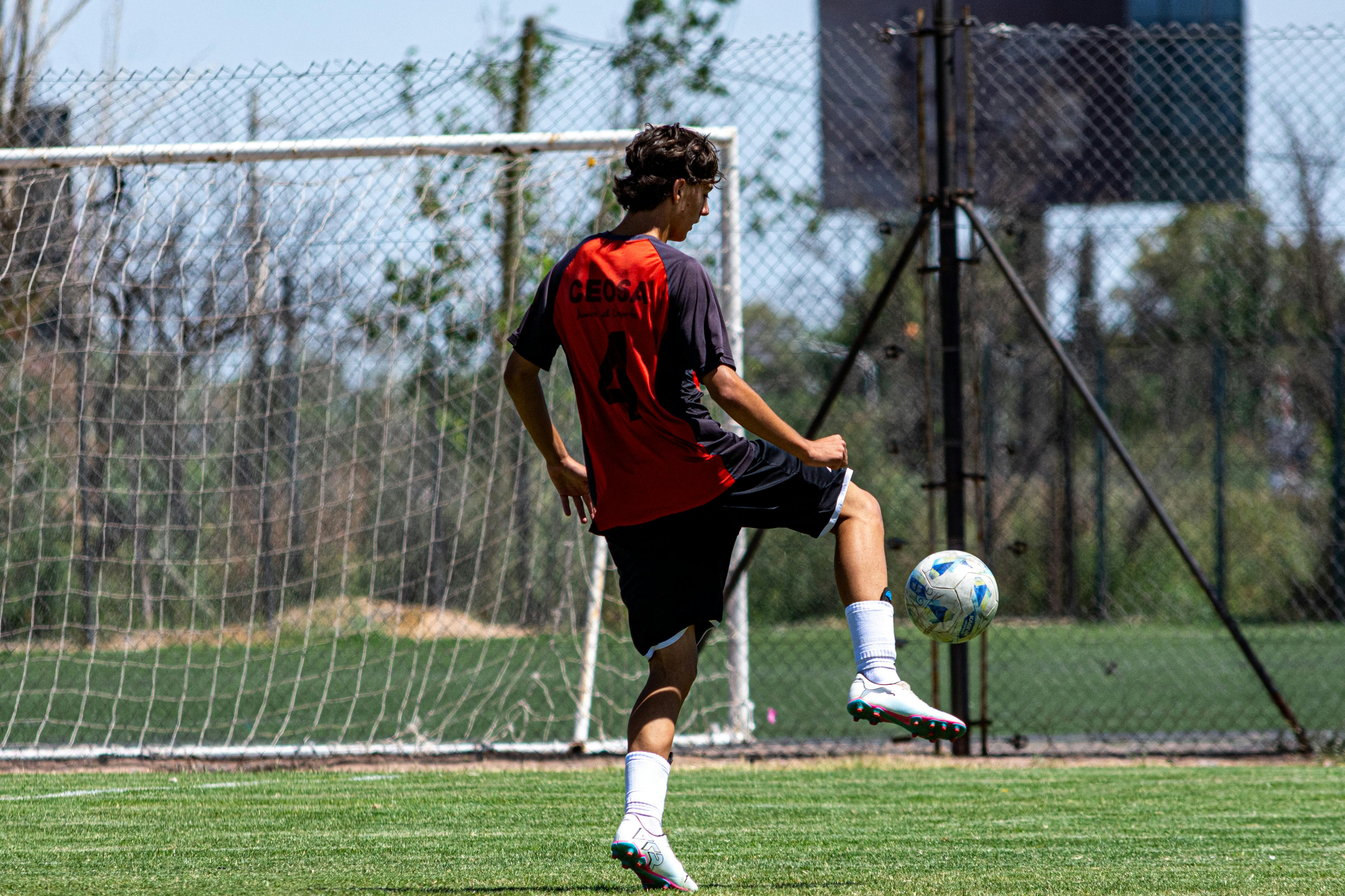 Young Soccer Player Practicing on Field · Free Stock Photo
