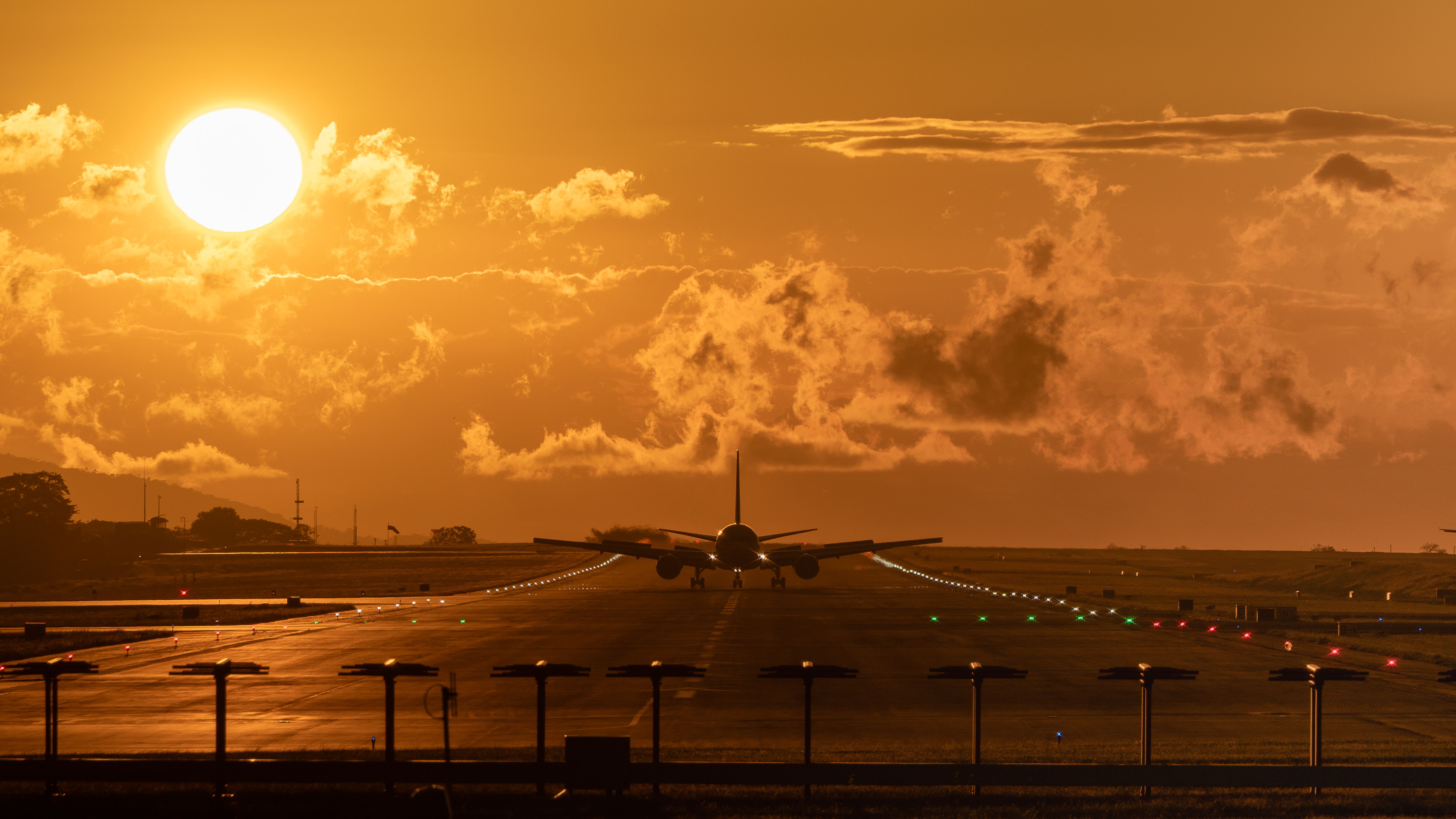 Airplane on Alajuela Airport Runway at Sunset · Free Stock Photo