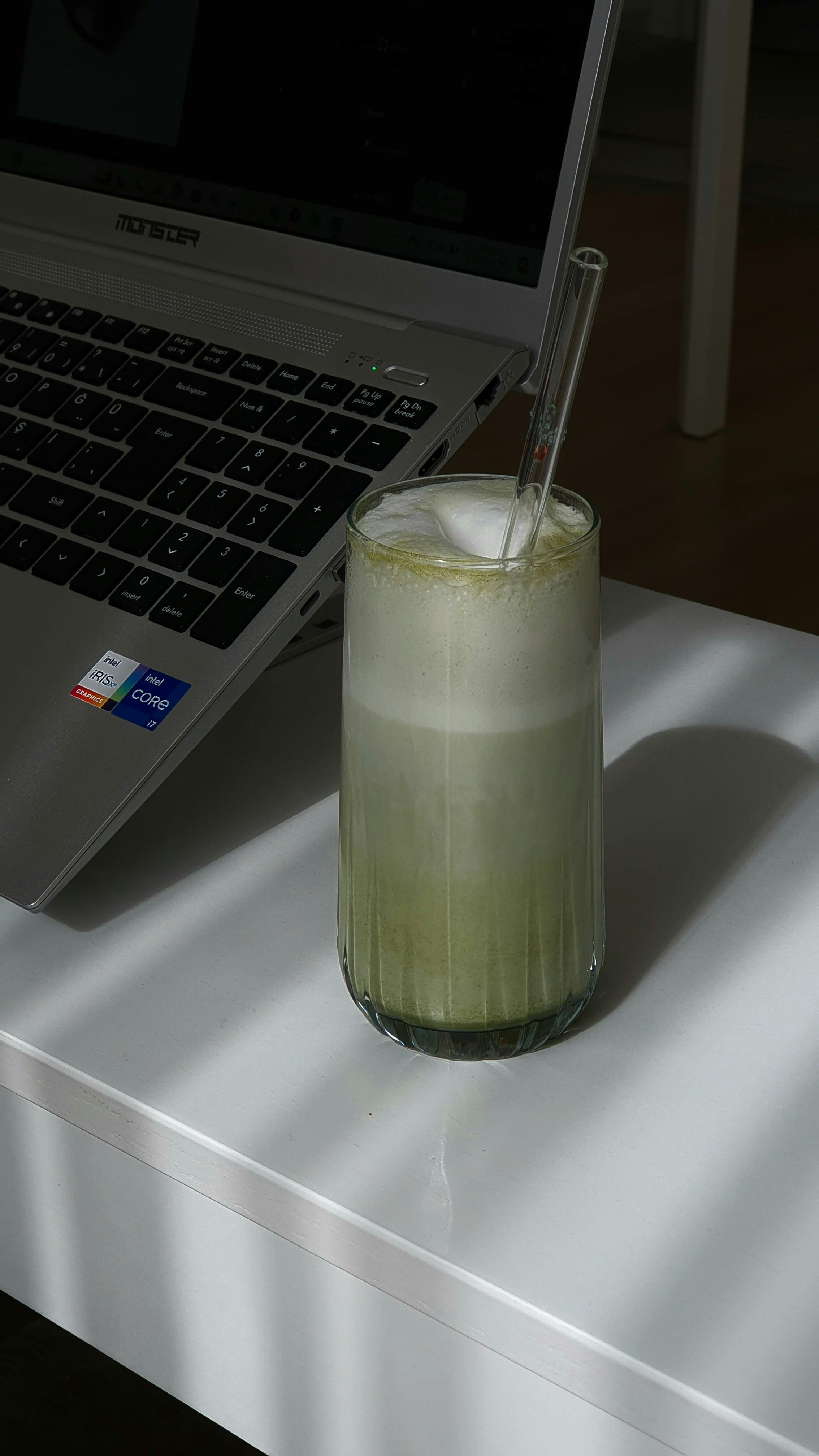 Iced Matcha Latte Beside a Laptop on Desk · Free Stock Photo