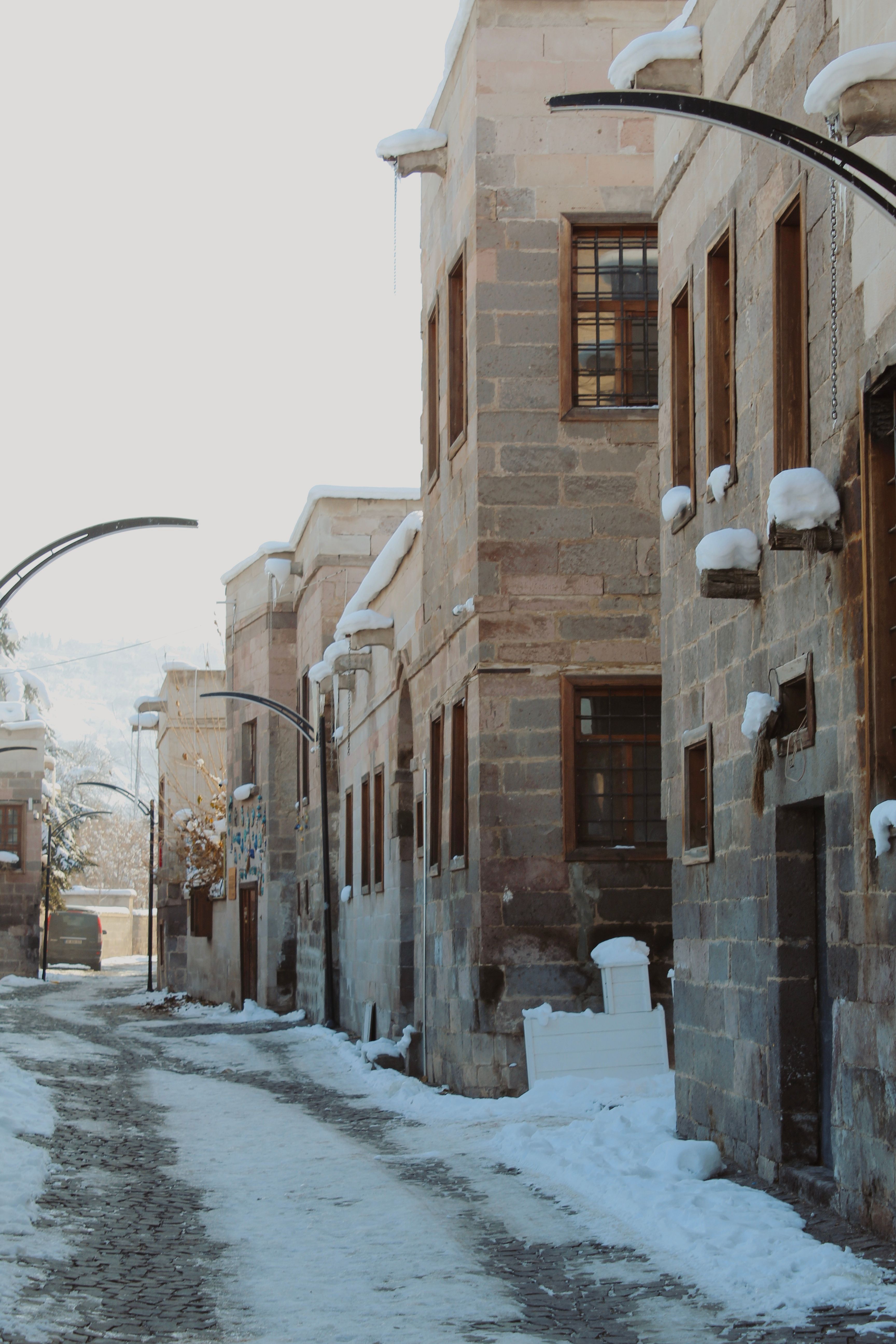 Historic Snowy Alley with Stone Buildings · Free Stock Photo