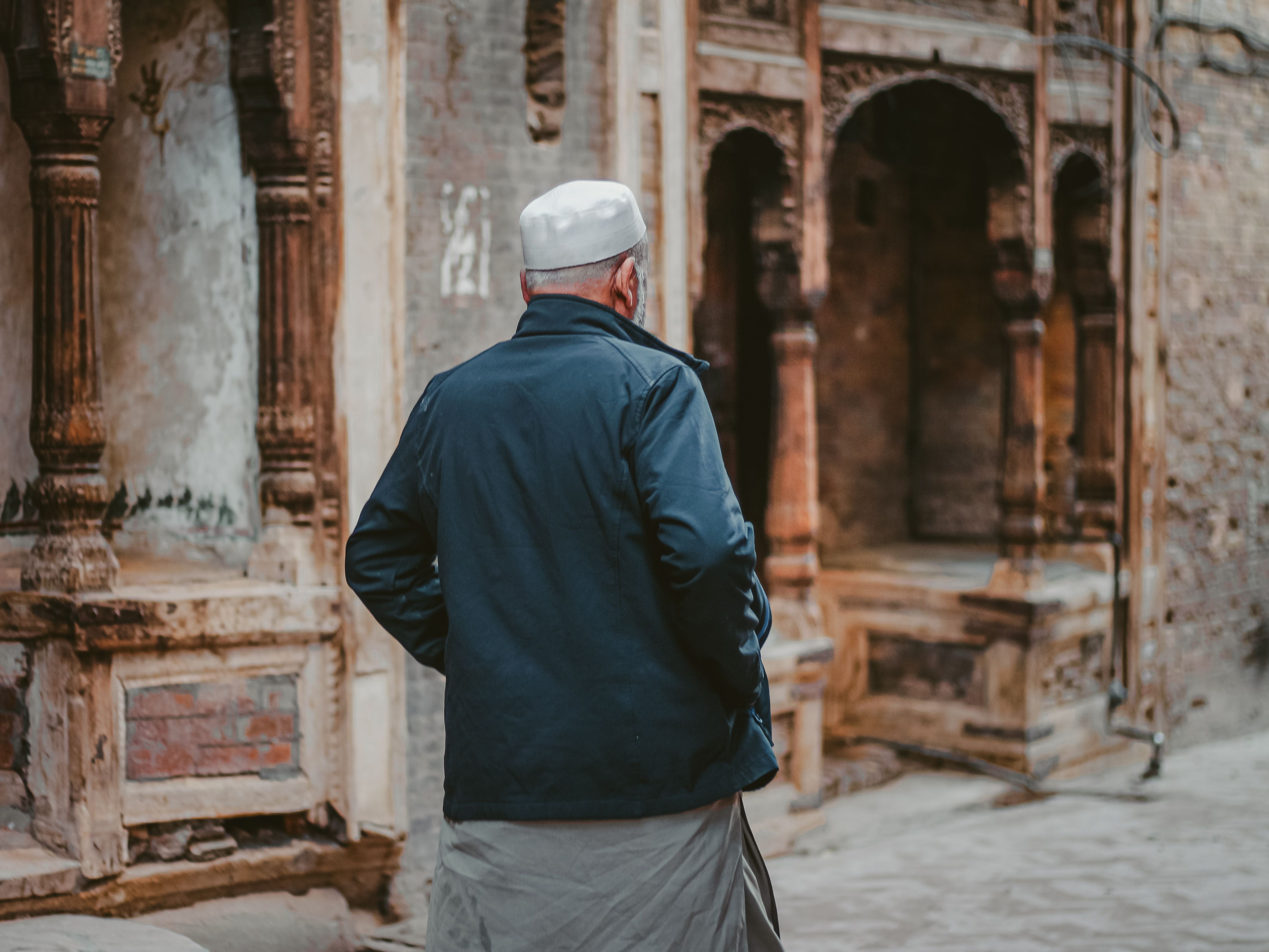 Elderly Man Walking in Old Pakistani Street · Free Stock Photo