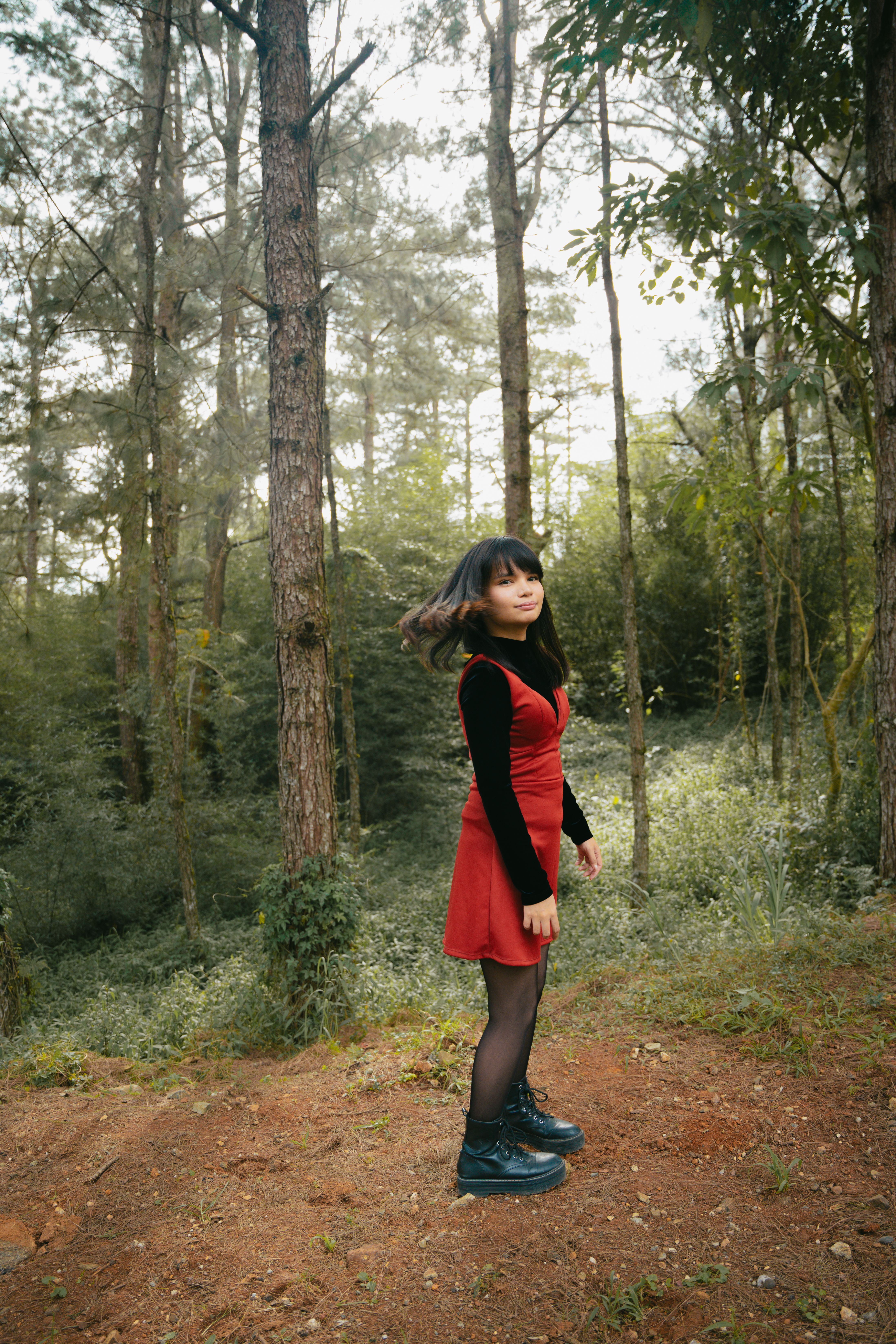 Woman in Red Dress Twirling in Forest · Free Stock Photo