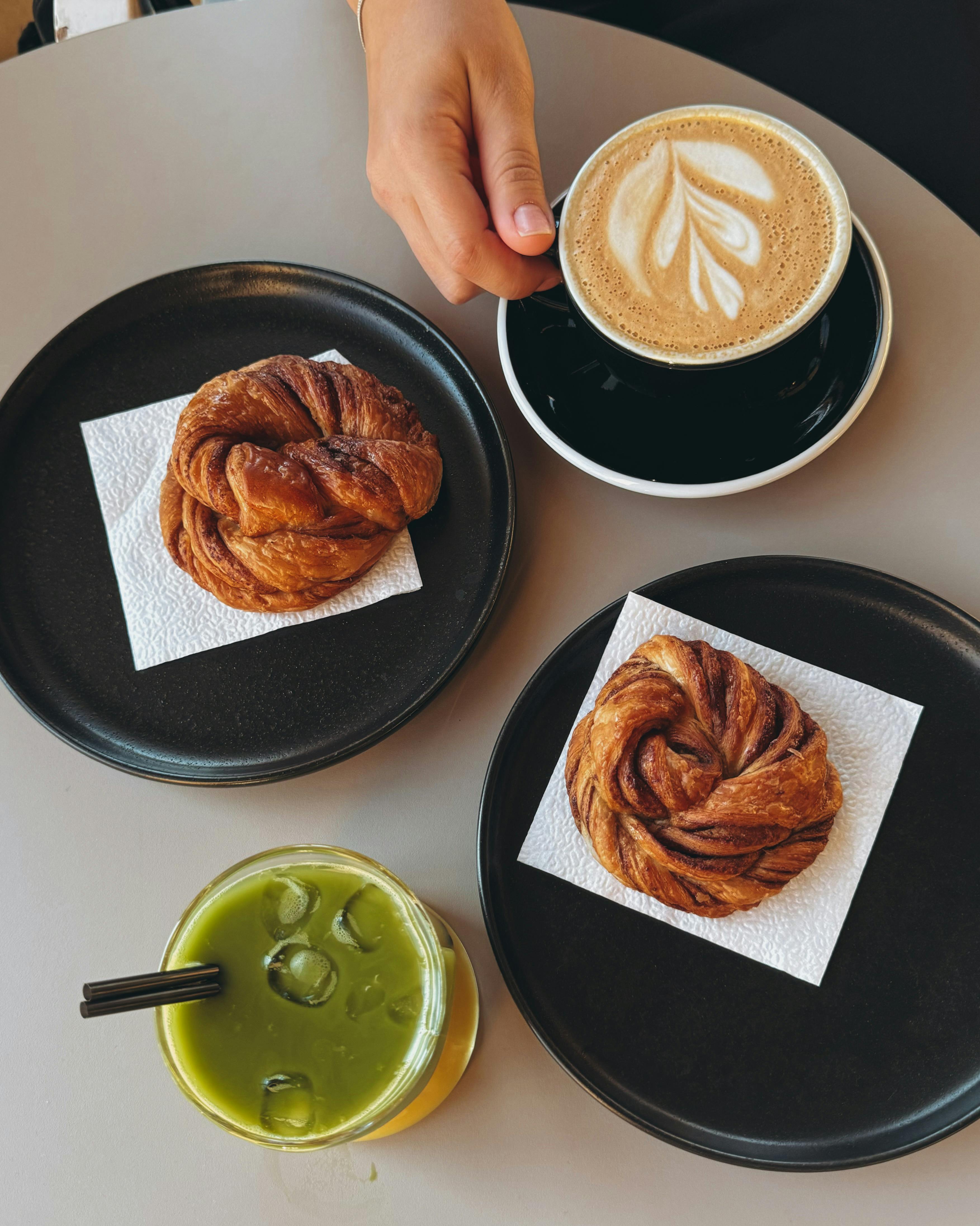 Delicious Coffee and Pastry Setup on Café Table · Free Stock Photo
