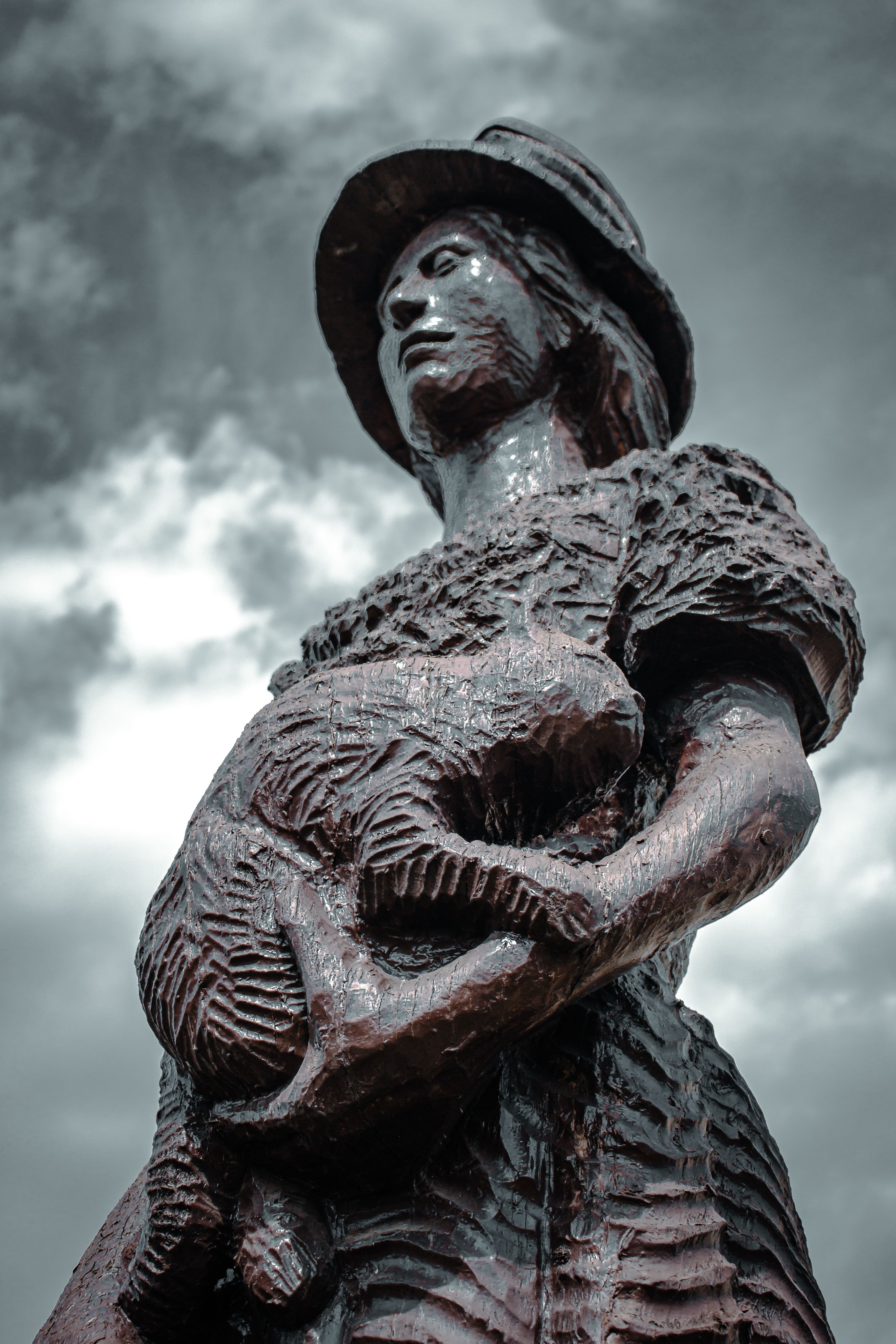 Striking Metal Statue Against Dramatic Sky · Free Stock Photo