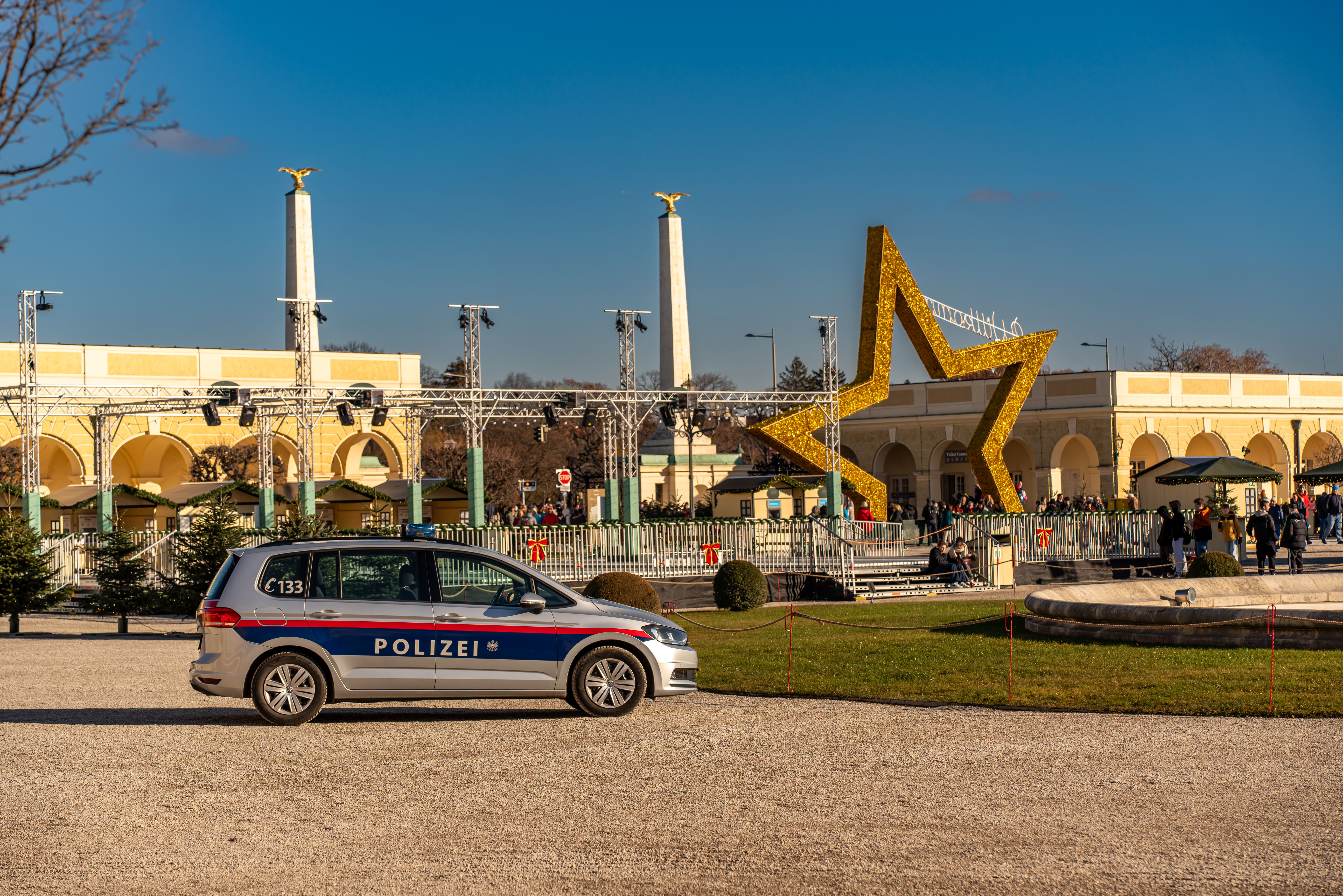 Police Car Near Christmas Market Star in Vienna · Free Stock Photo