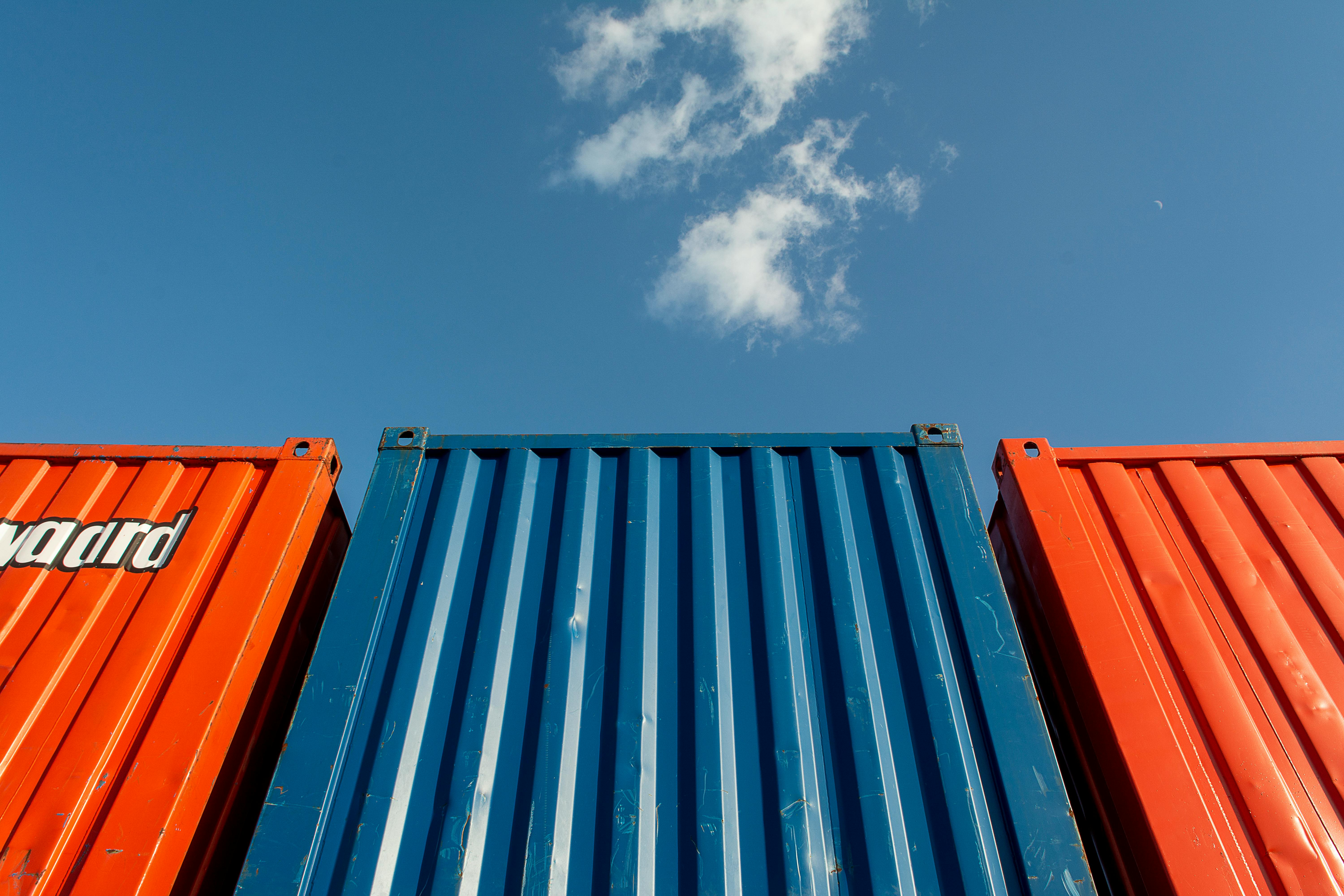 Colorful Shipping Containers Against Blue Sky · Free Stock Photo