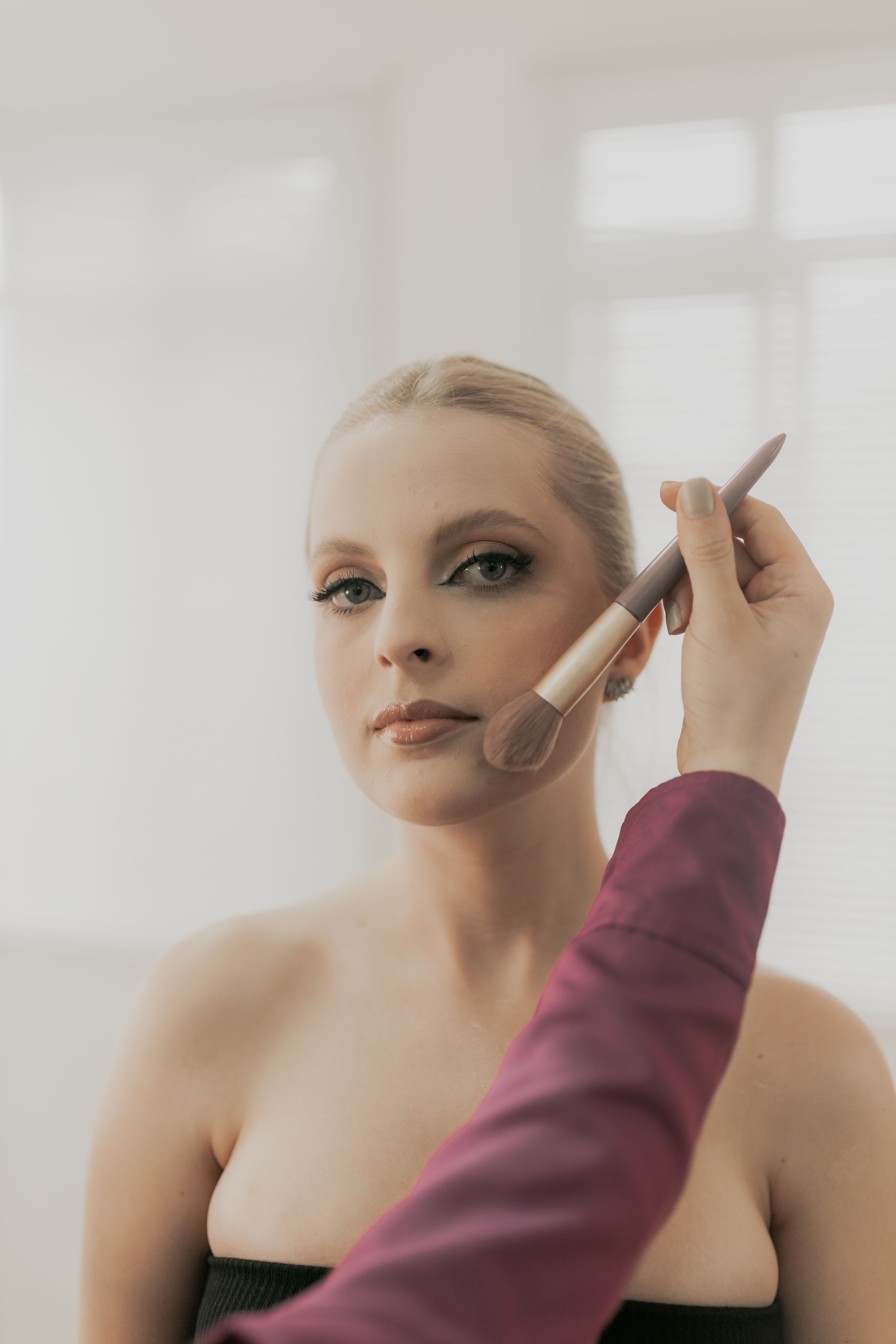 Professional Makeup Application in Soft Light · Free Stock Photo