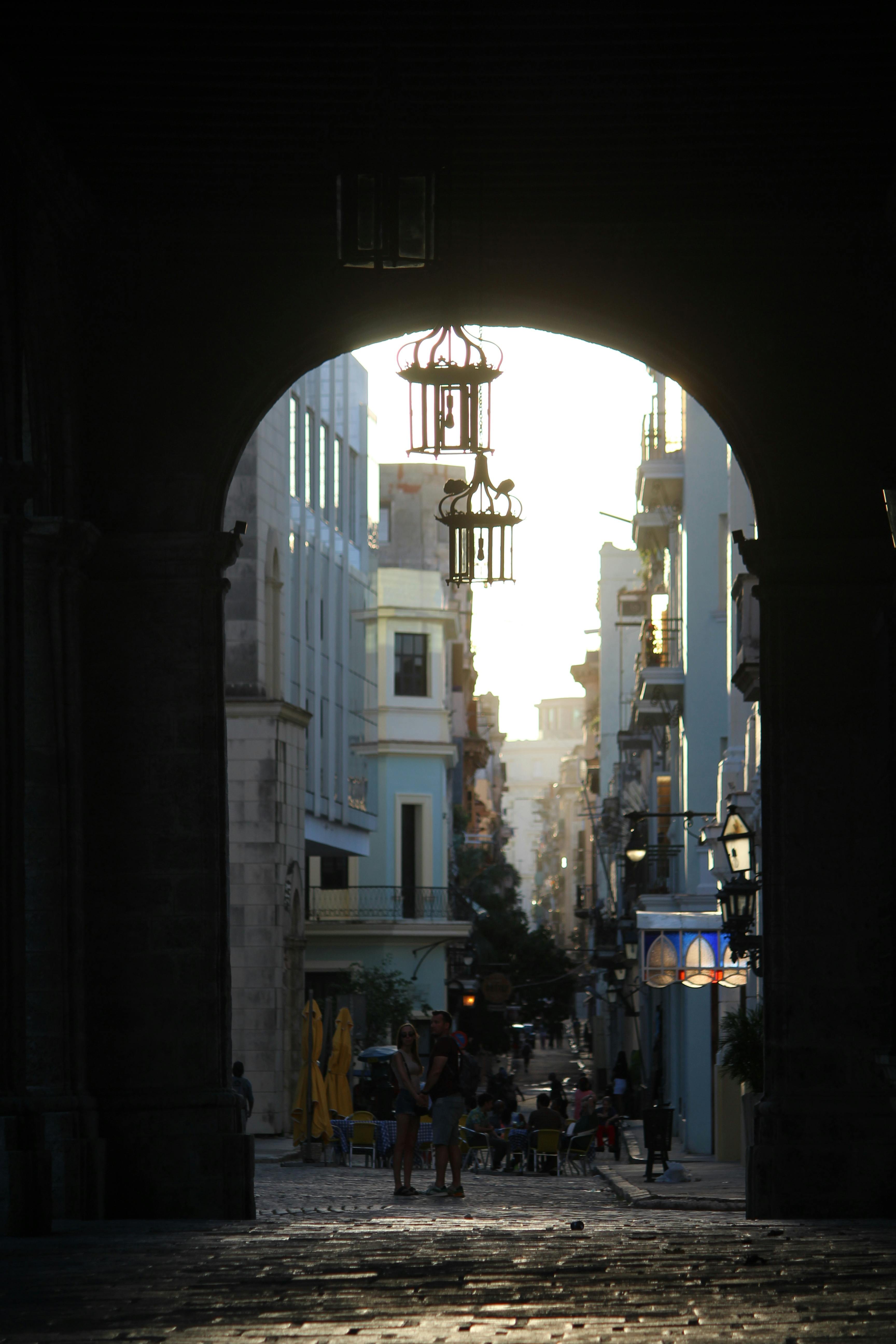 Charming Street View Through Archway at Sunset · Free Stock Photo