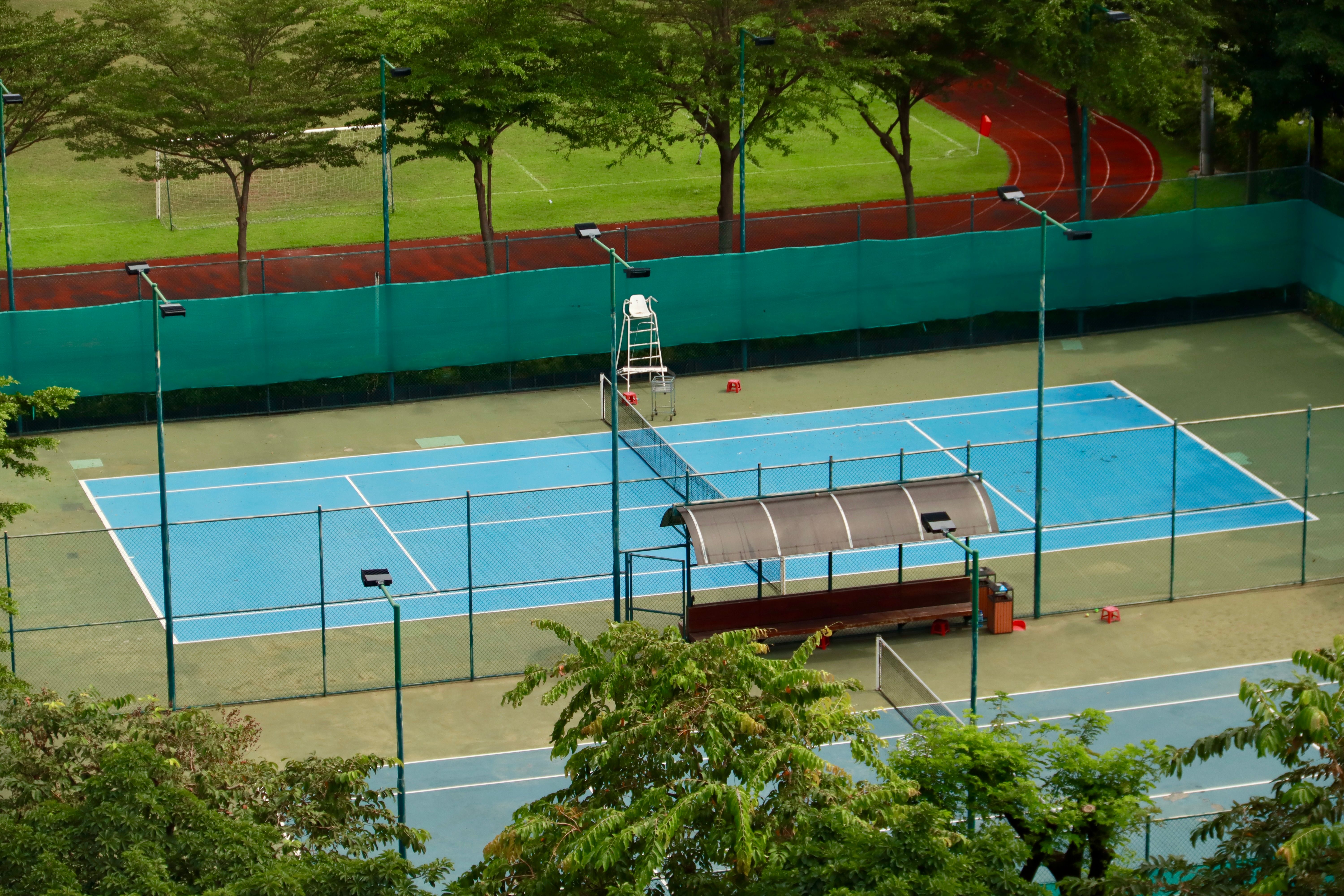 Aerial View of Outdoor Tennis Court in Lush Park · Free Stock Photo