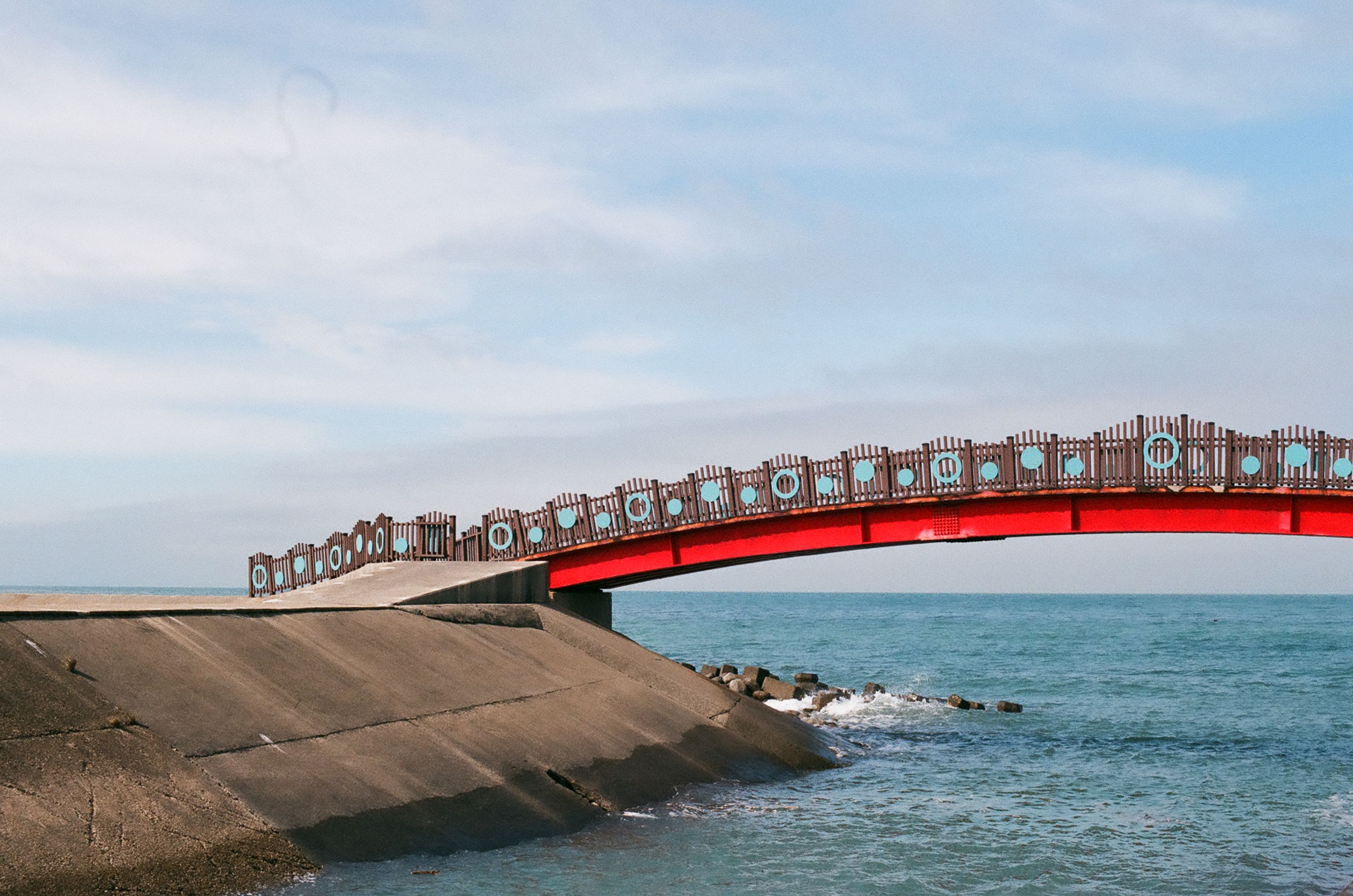 Vibrant Red Bridge Over Blue Ocean in Taiwan · Free Stock Photo