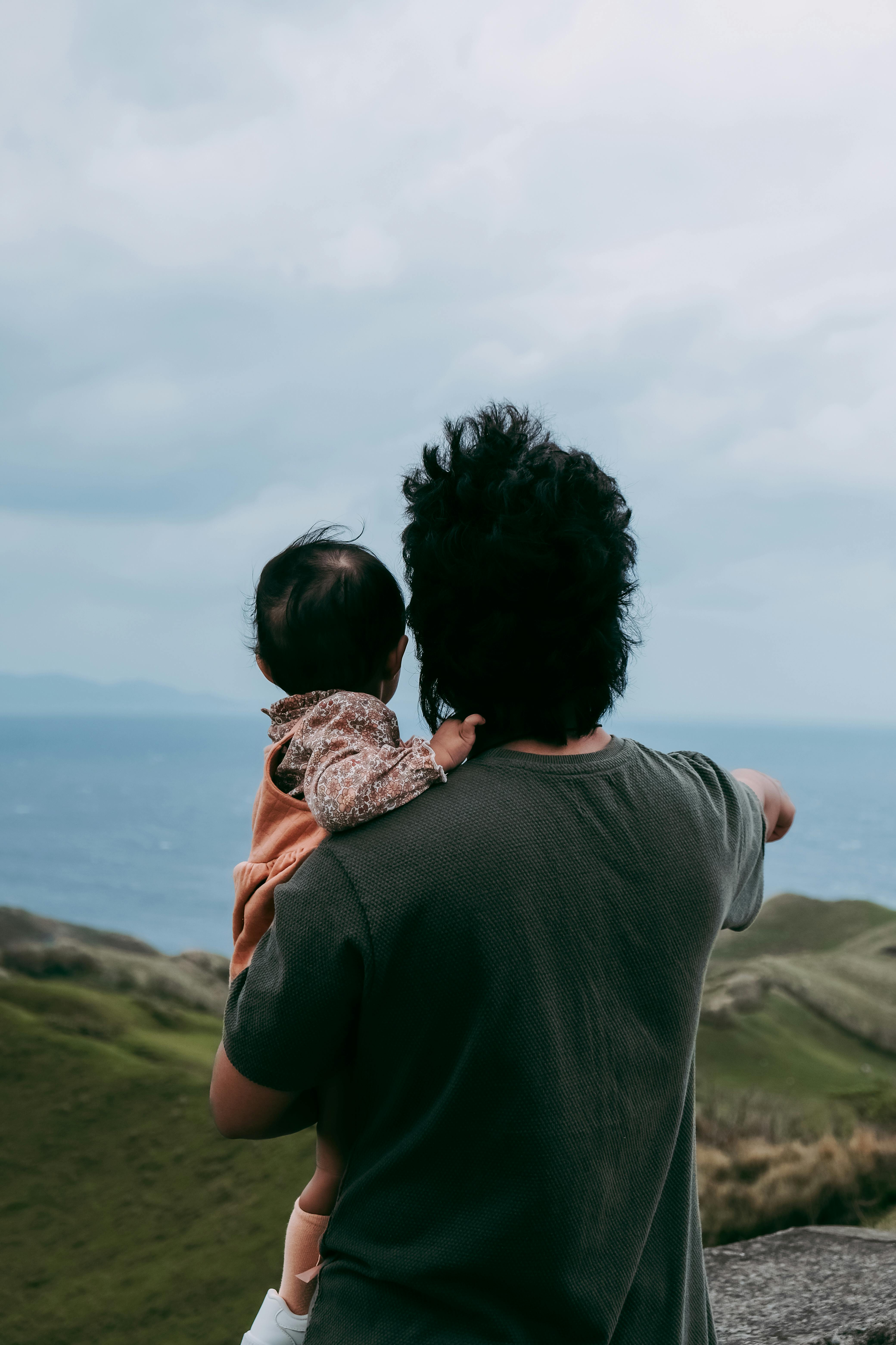 Father and Child Enjoying Scenic Ocean View · Free Stock Photo