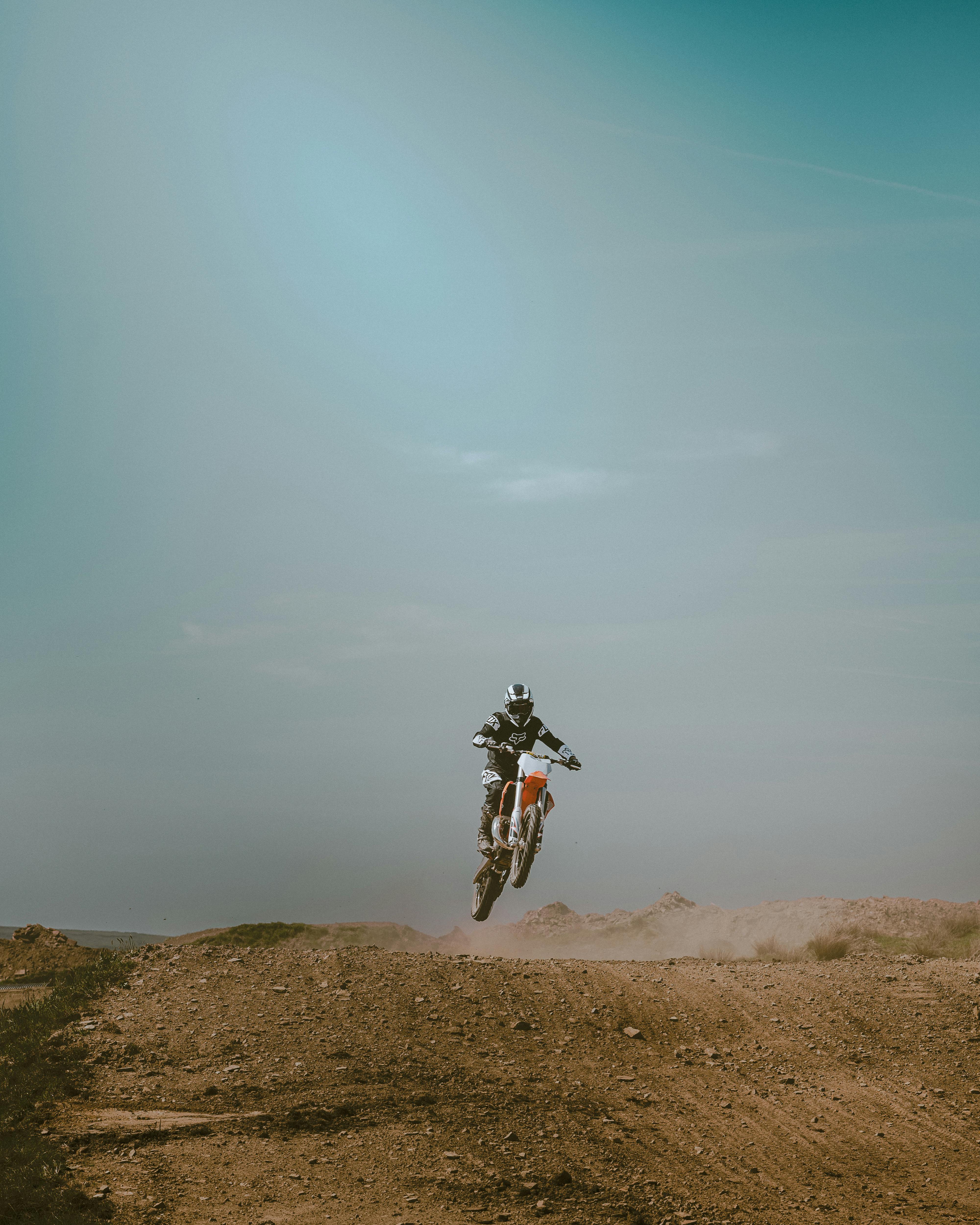 High-Flying Dirt Bike Stunt in Open Terrain · Free Stock Photo