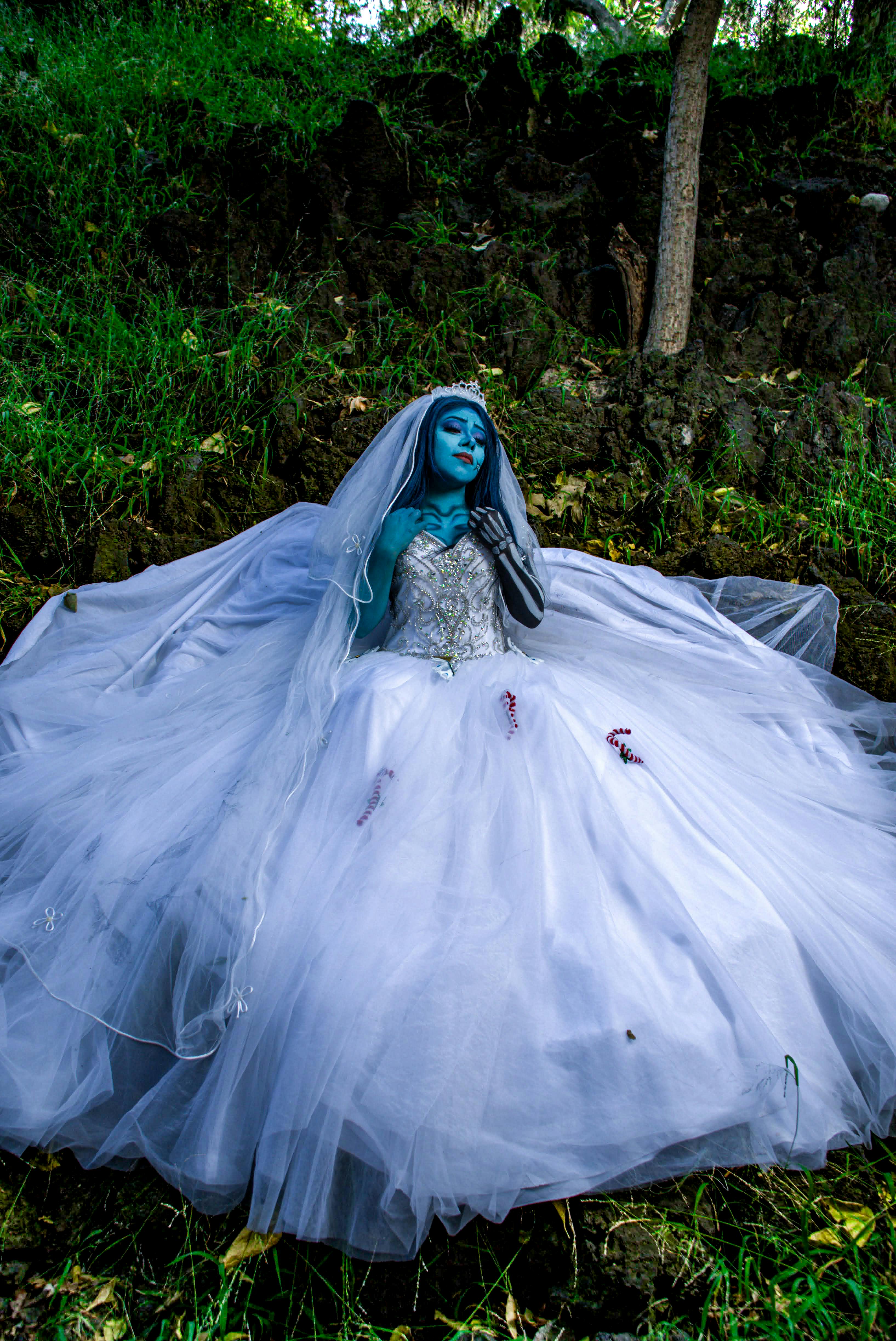 Fantasy Bride Resting Outdoors in White Gown · Free Stock Photo