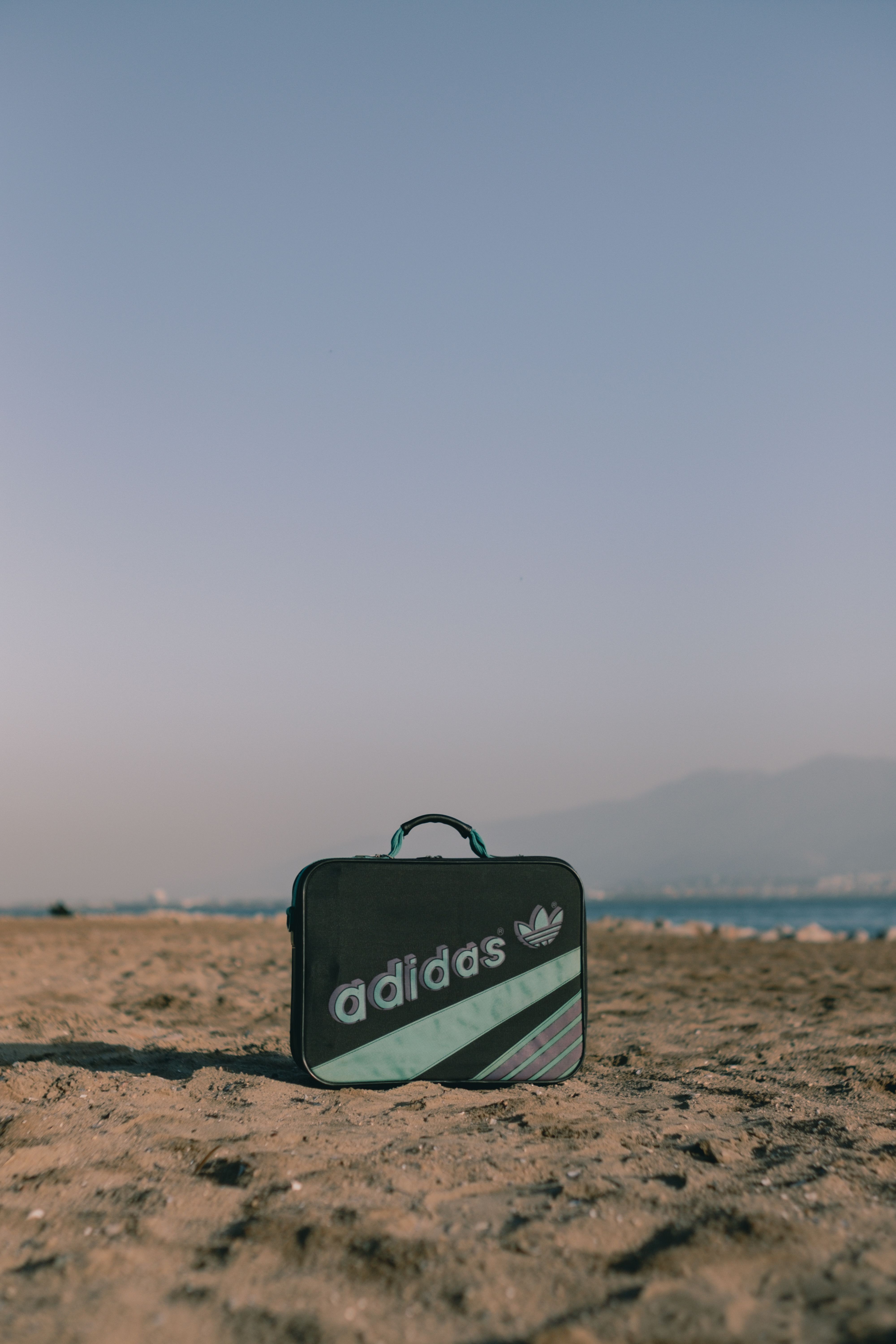 Adidas Bag on Beachfront with Mountain View · Free Stock Photo