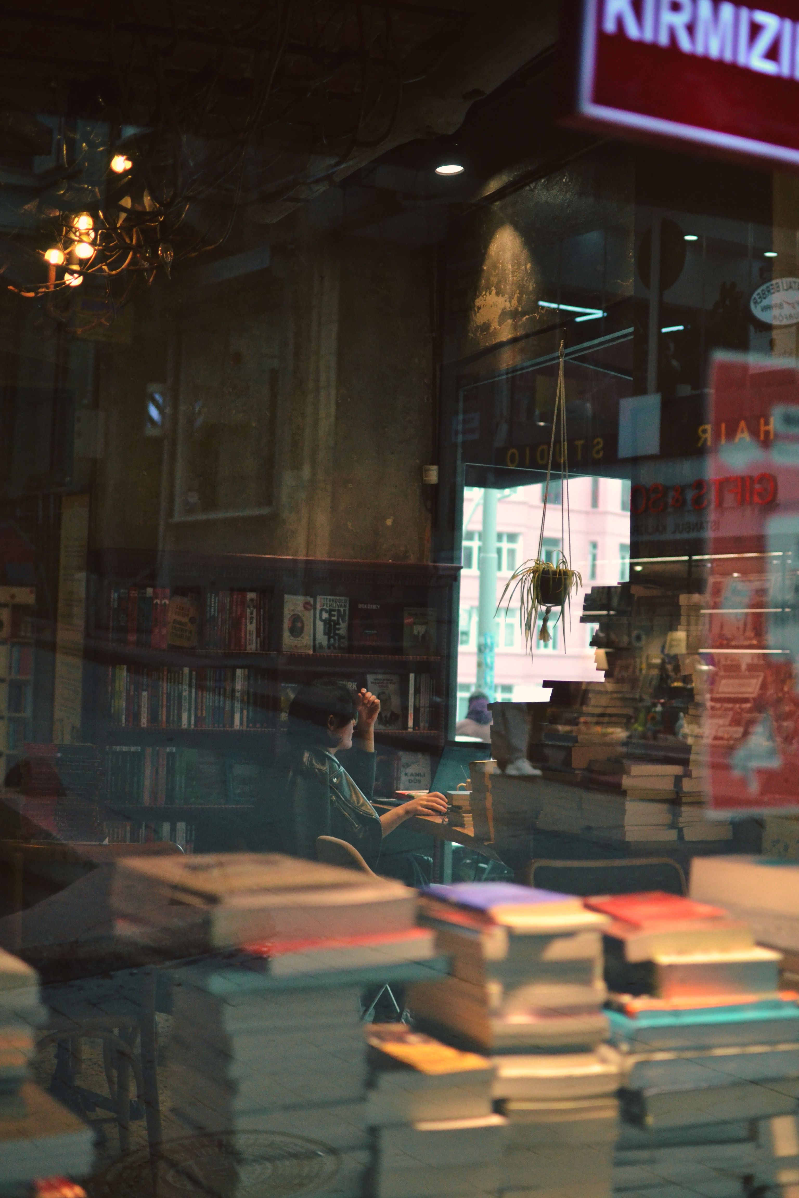 Cozy Bookstore with Reflections and Books Stacked · Free Stock Photo