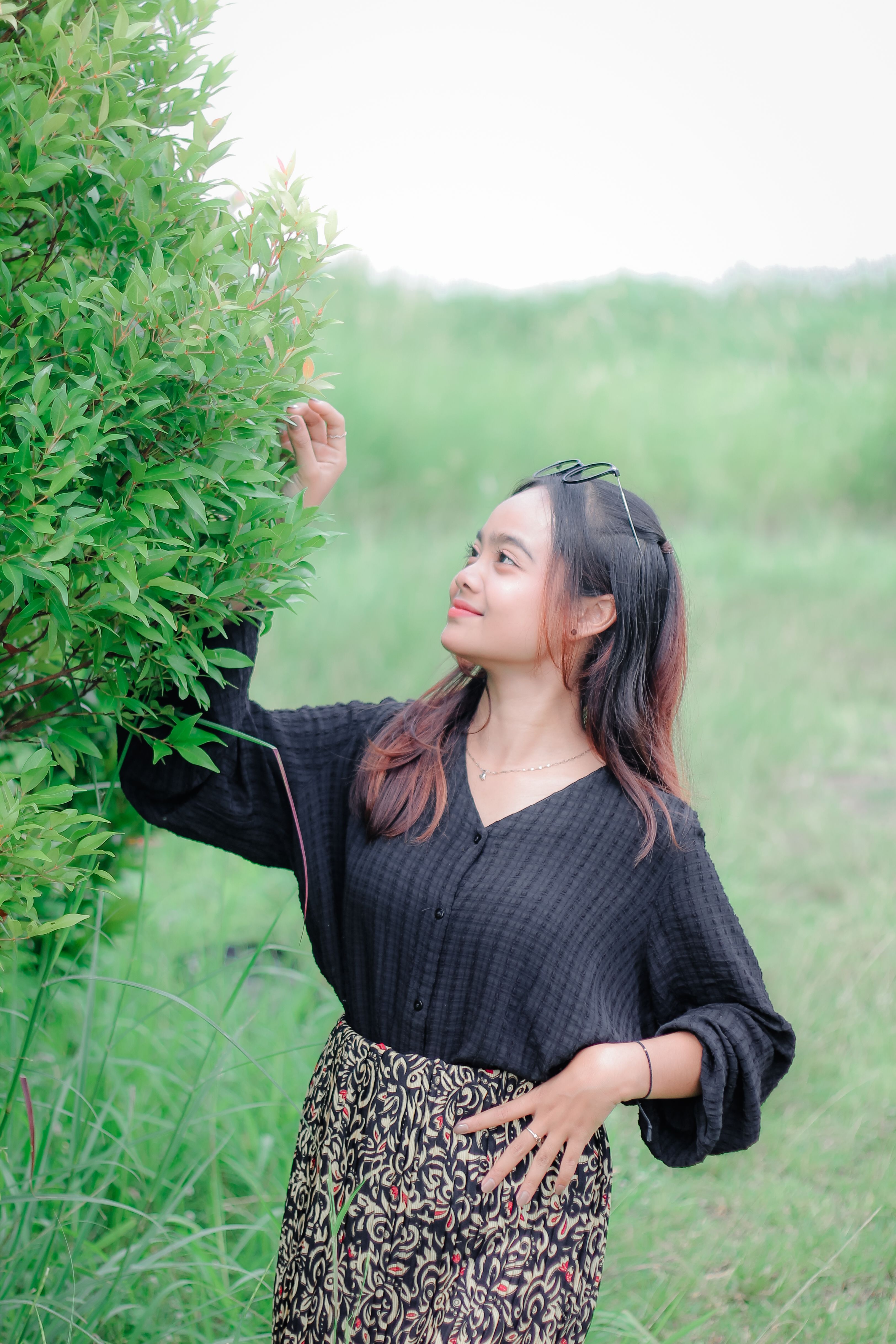Young Woman Enjoying Nature in Lush Greenery · Free Stock Photo