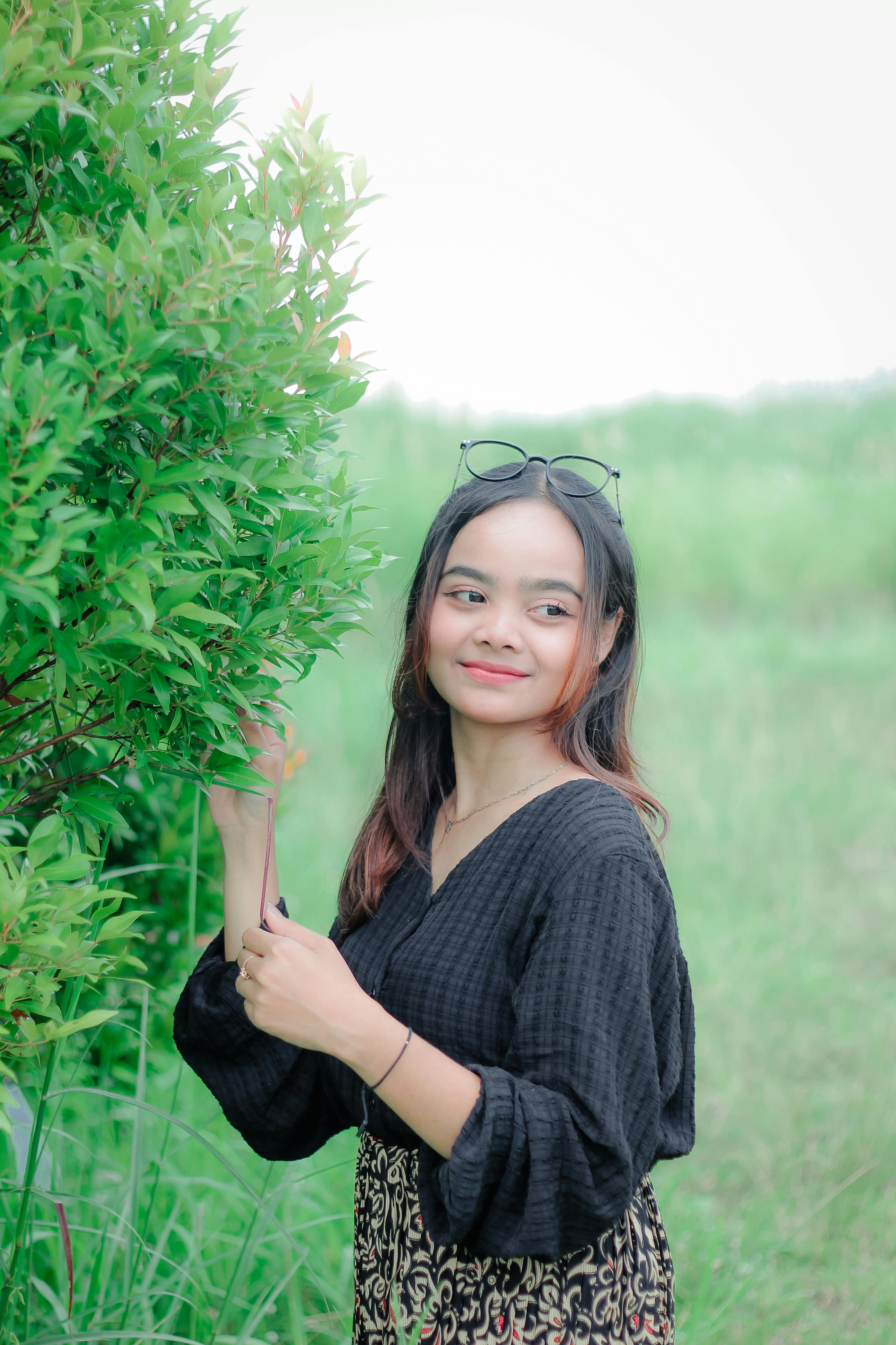 Young Woman Enjoying Nature in Lush Greenery · Free Stock Photo