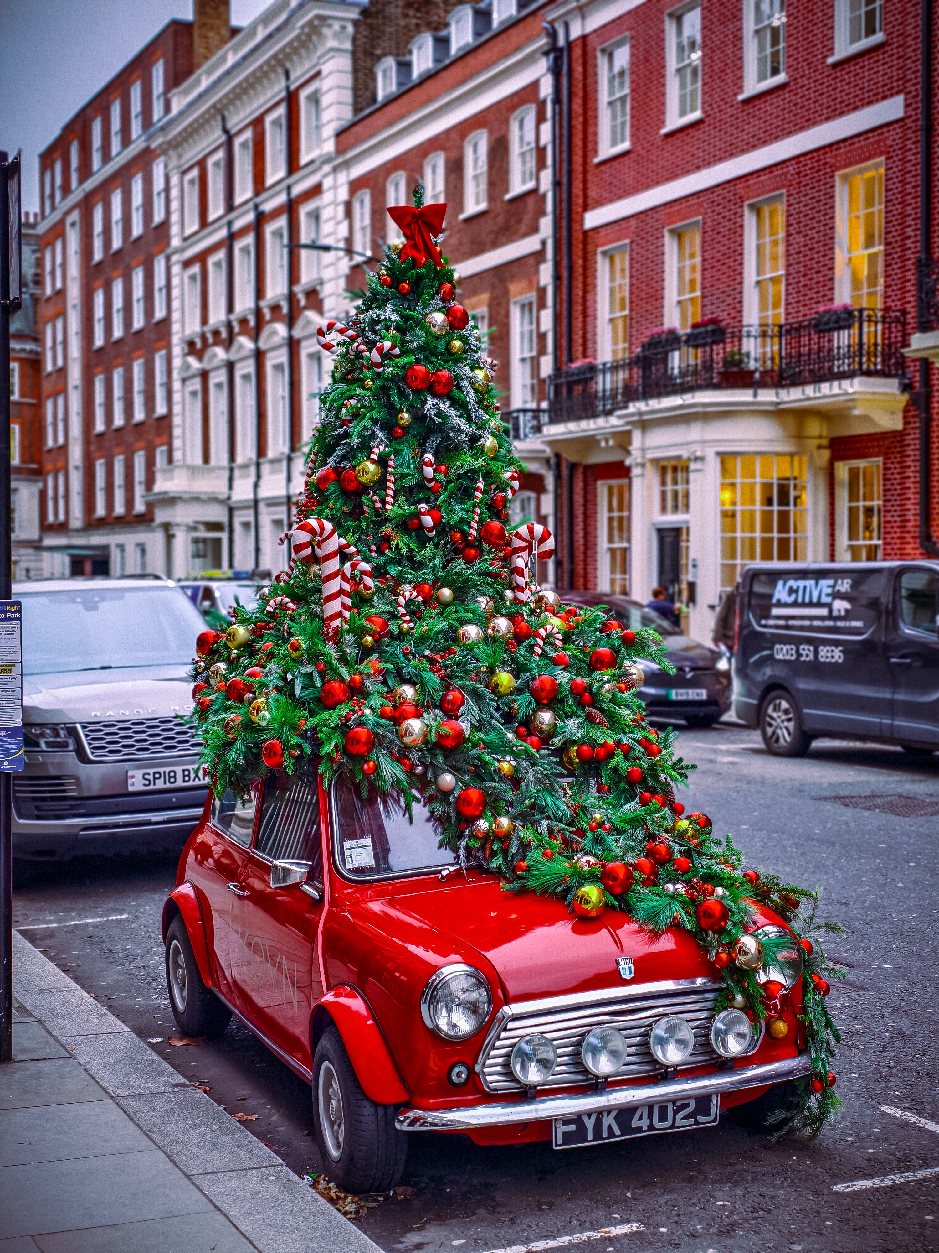 Festive Mini Car Decorated with Christmas Tree · Free Stock Photo
