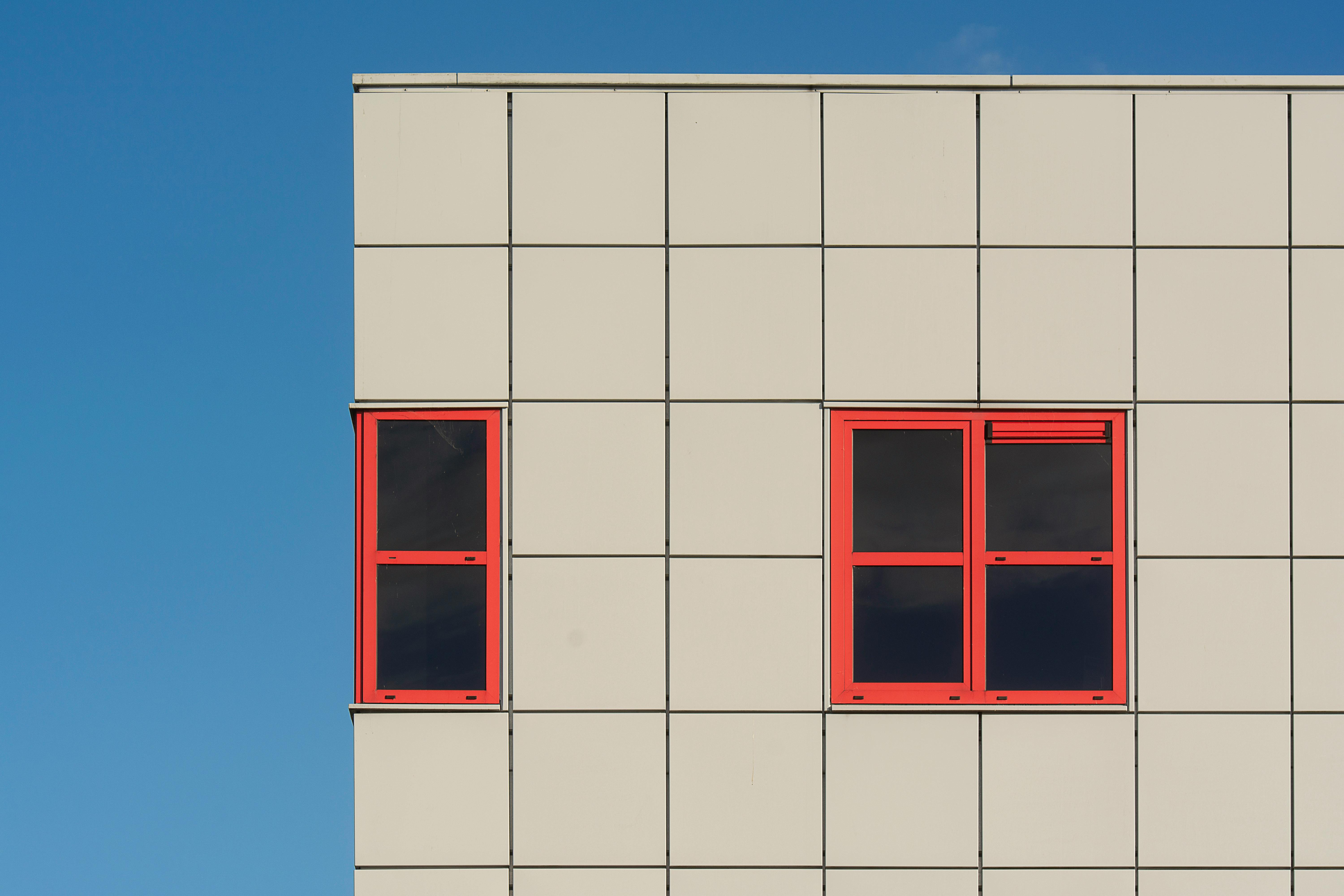 Low Angle Photo of a Red Textured Building Exterior · Free Stock Photo
