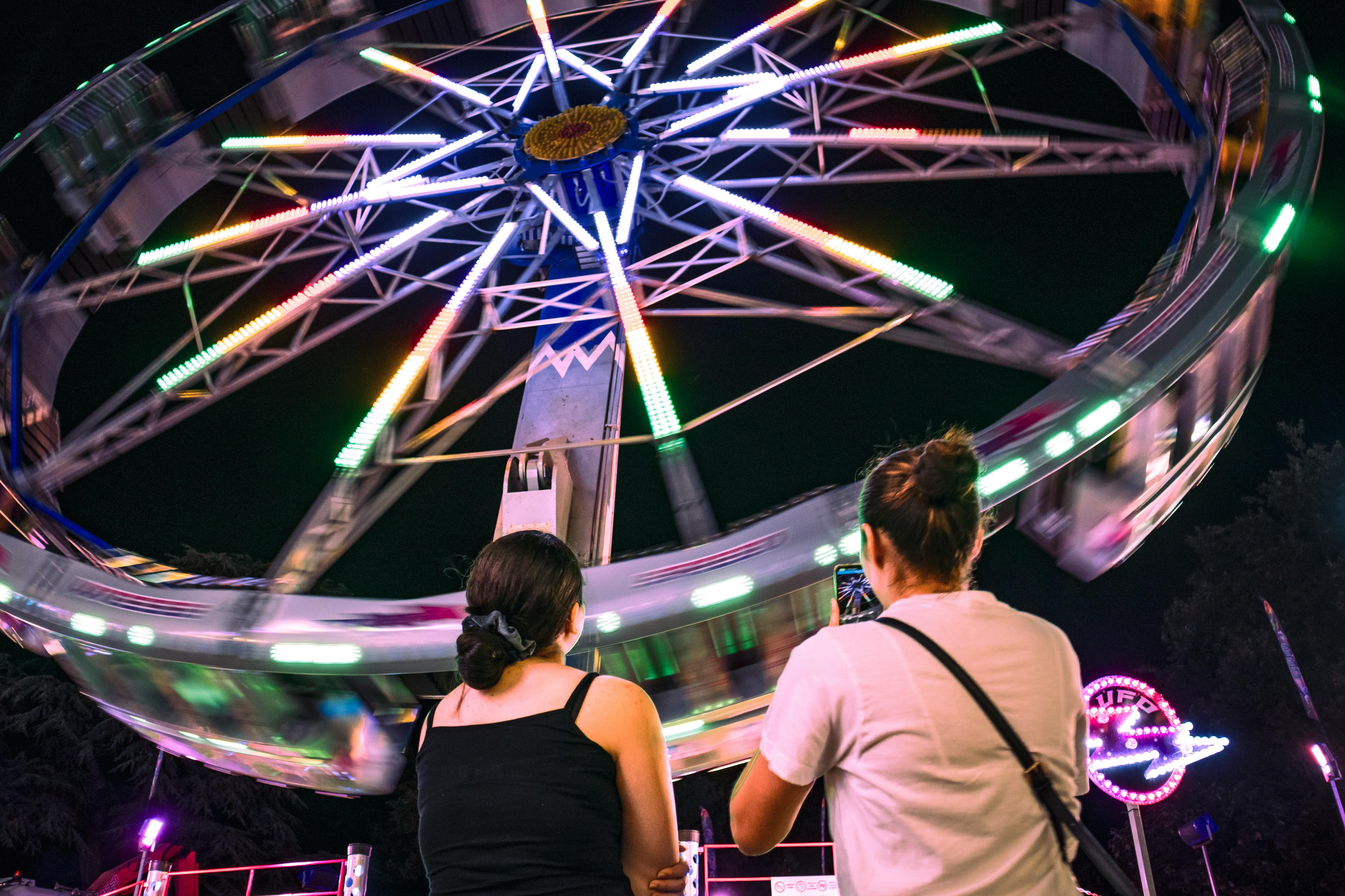 Nighttime Amusement Ride with Observers · Free Stock Photo