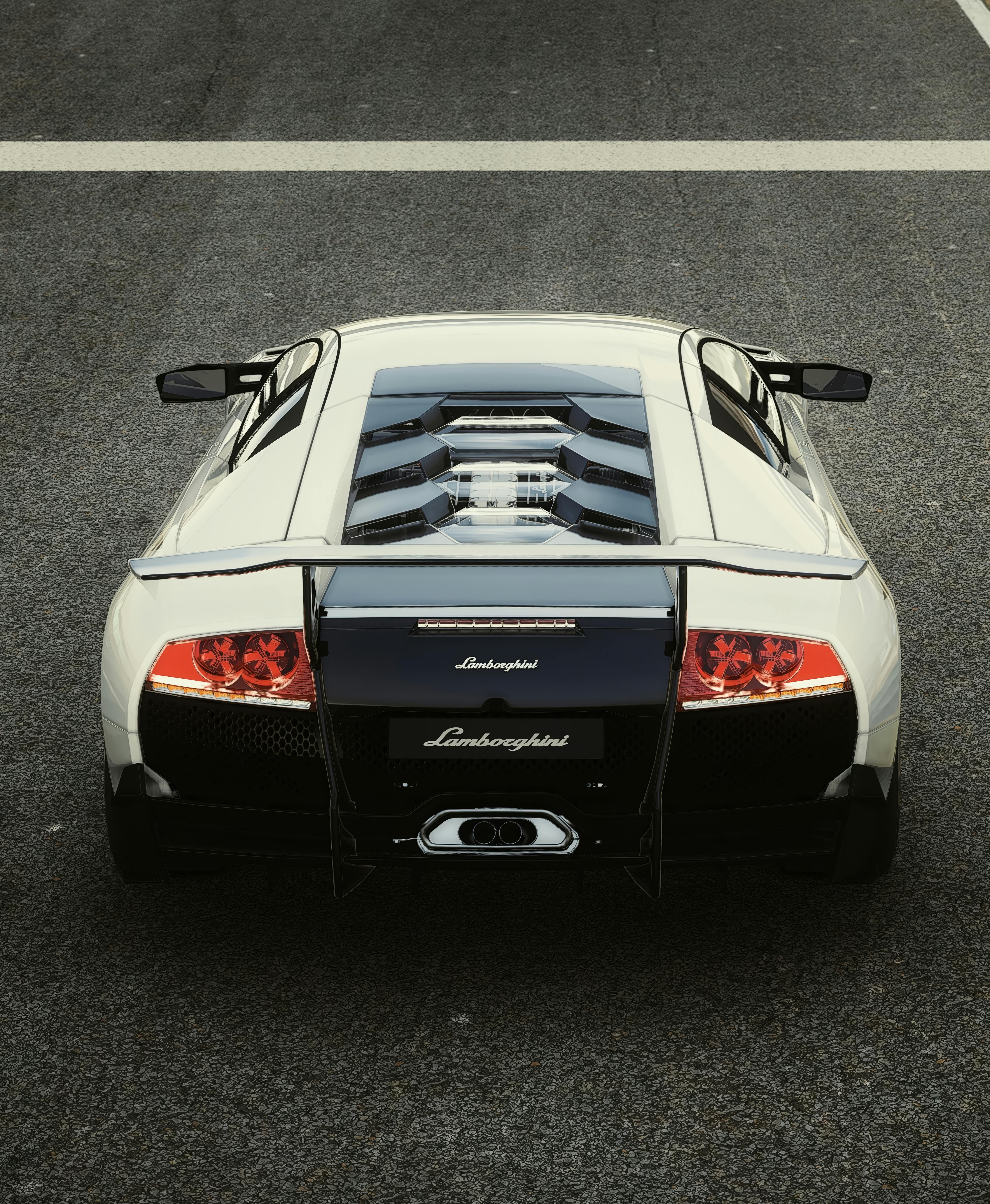 Rear View of a Luxury Sports Car on an Open Road · Free Stock Photo