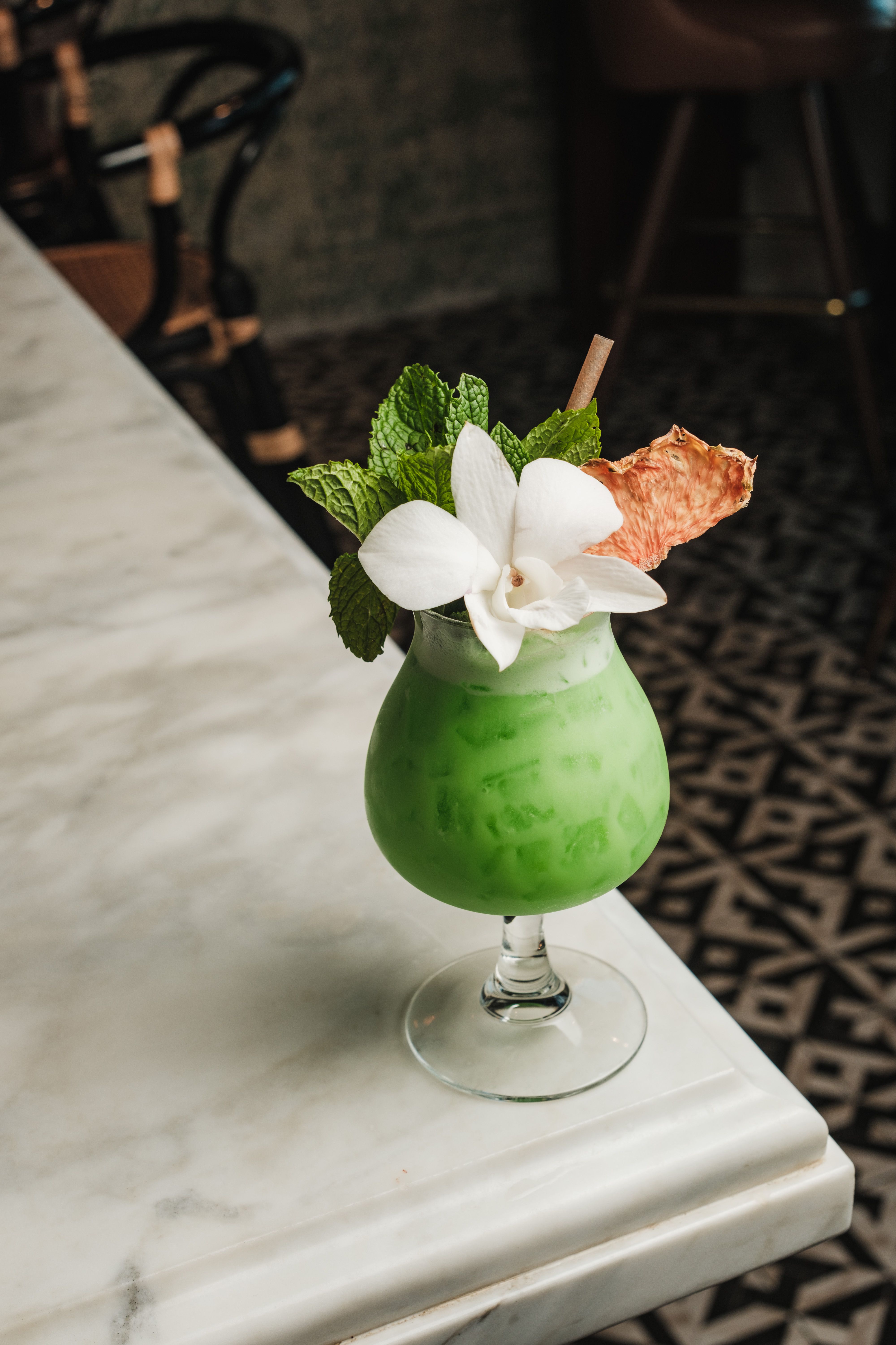 Refreshing Green Mocktail with Floral Garnish · Free Stock Photo