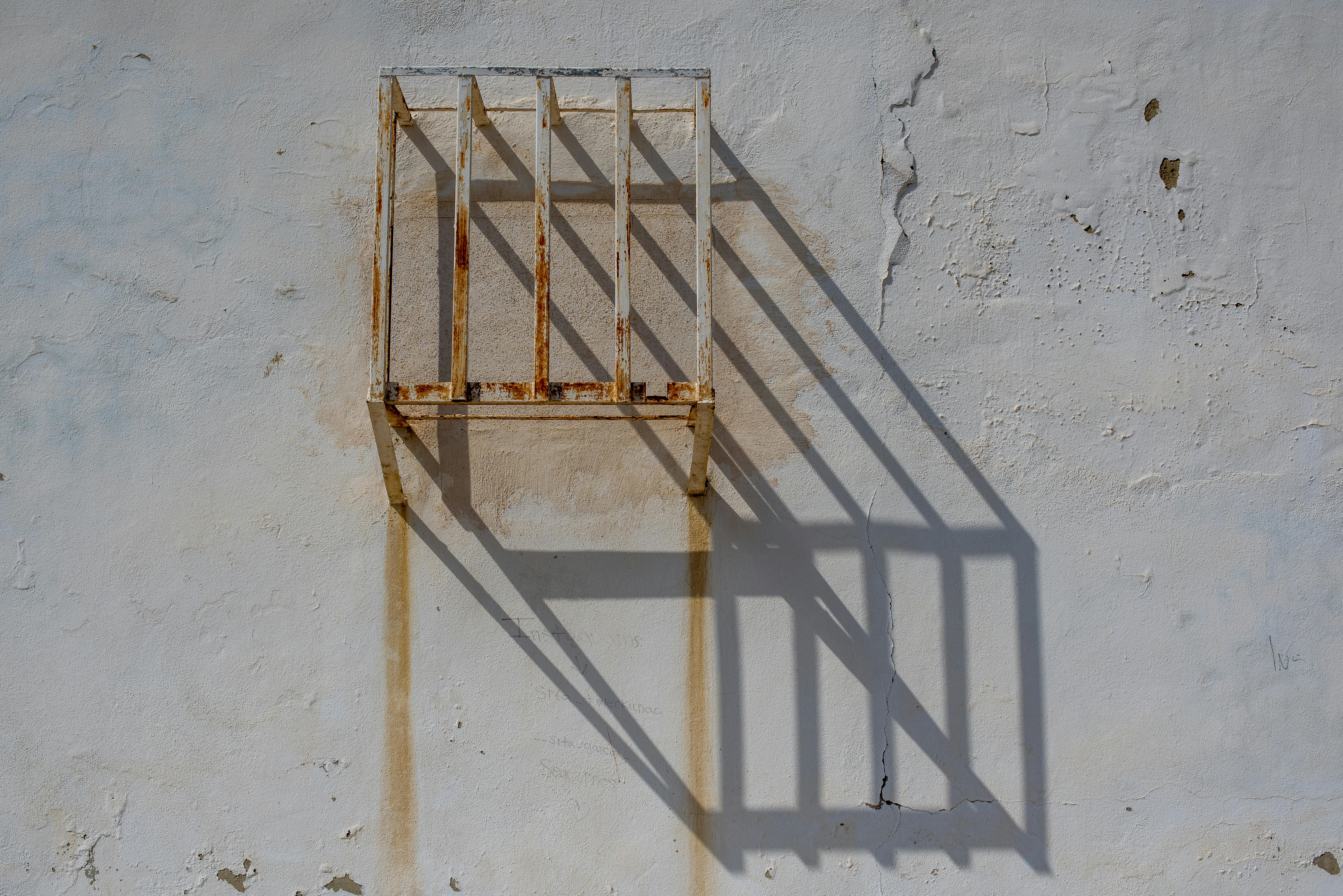 Rusty Metal Grate Casting Shadow on Wall · Free Stock Photo
