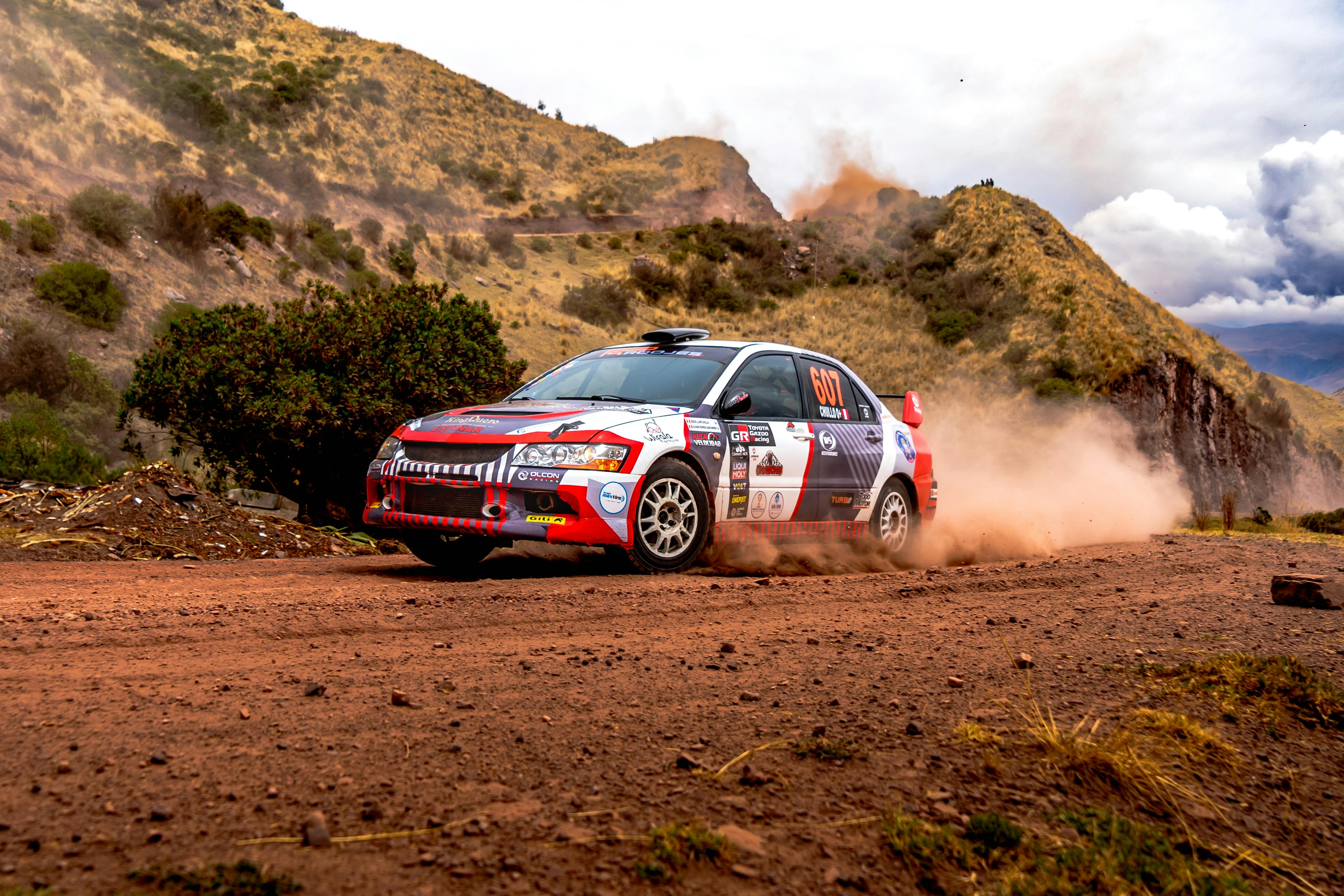 Exciting Rally Car Racing on Mountain Dirt Track · Free Stock Photo