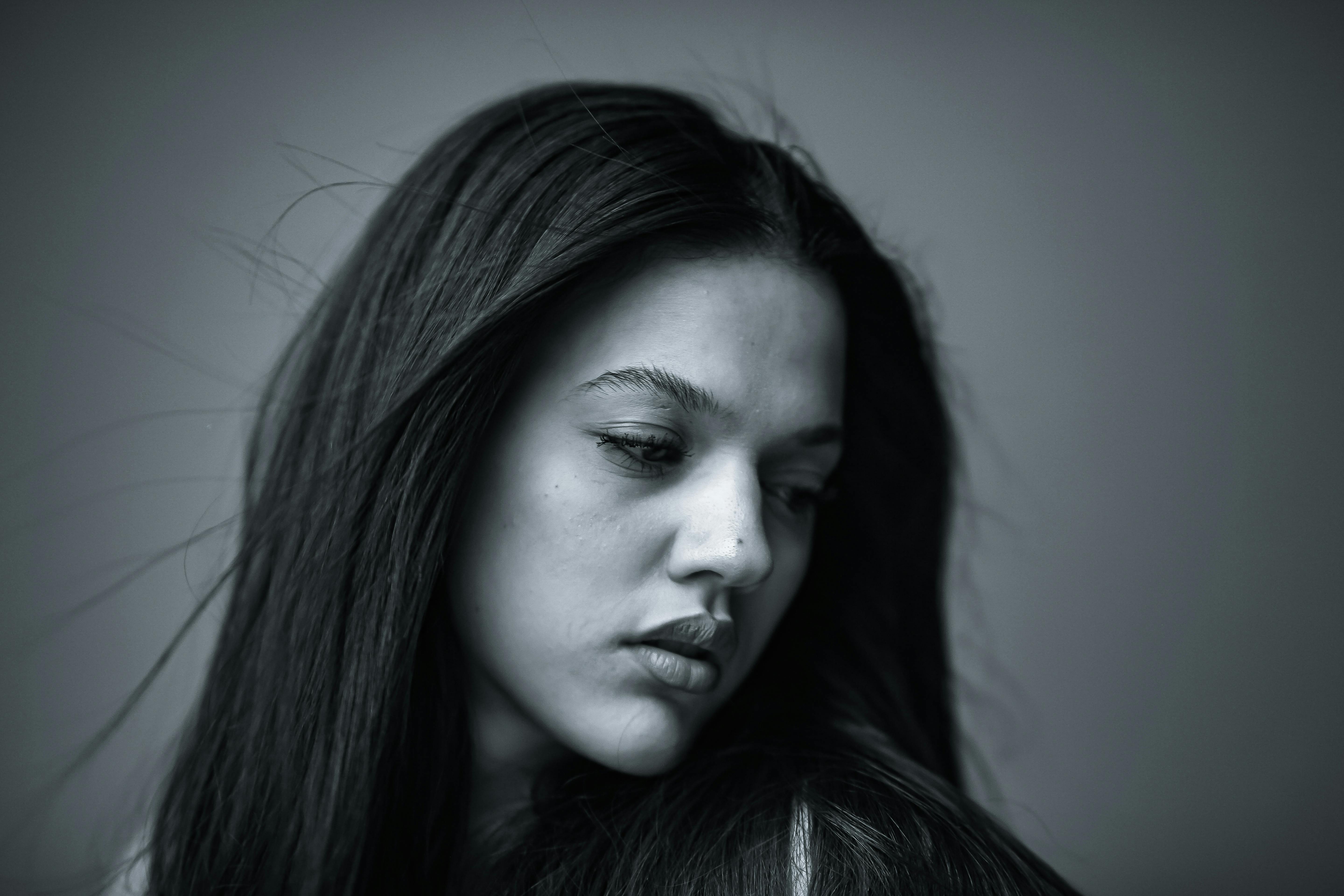 Black and White Portrait of a Reflective Woman · Free Stock Photo