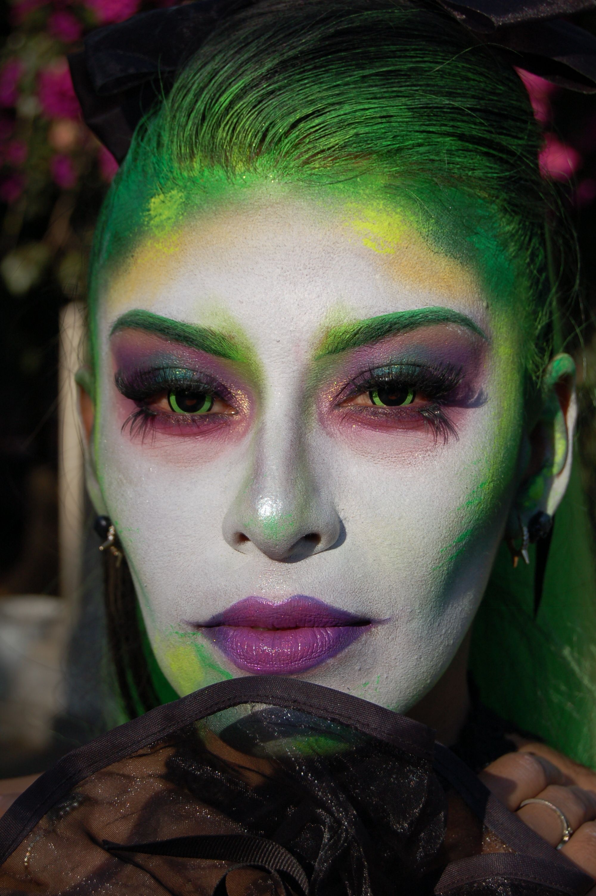 Vibrant Cosplay Character with Green Makeup Outdoors · Free Stock Photo