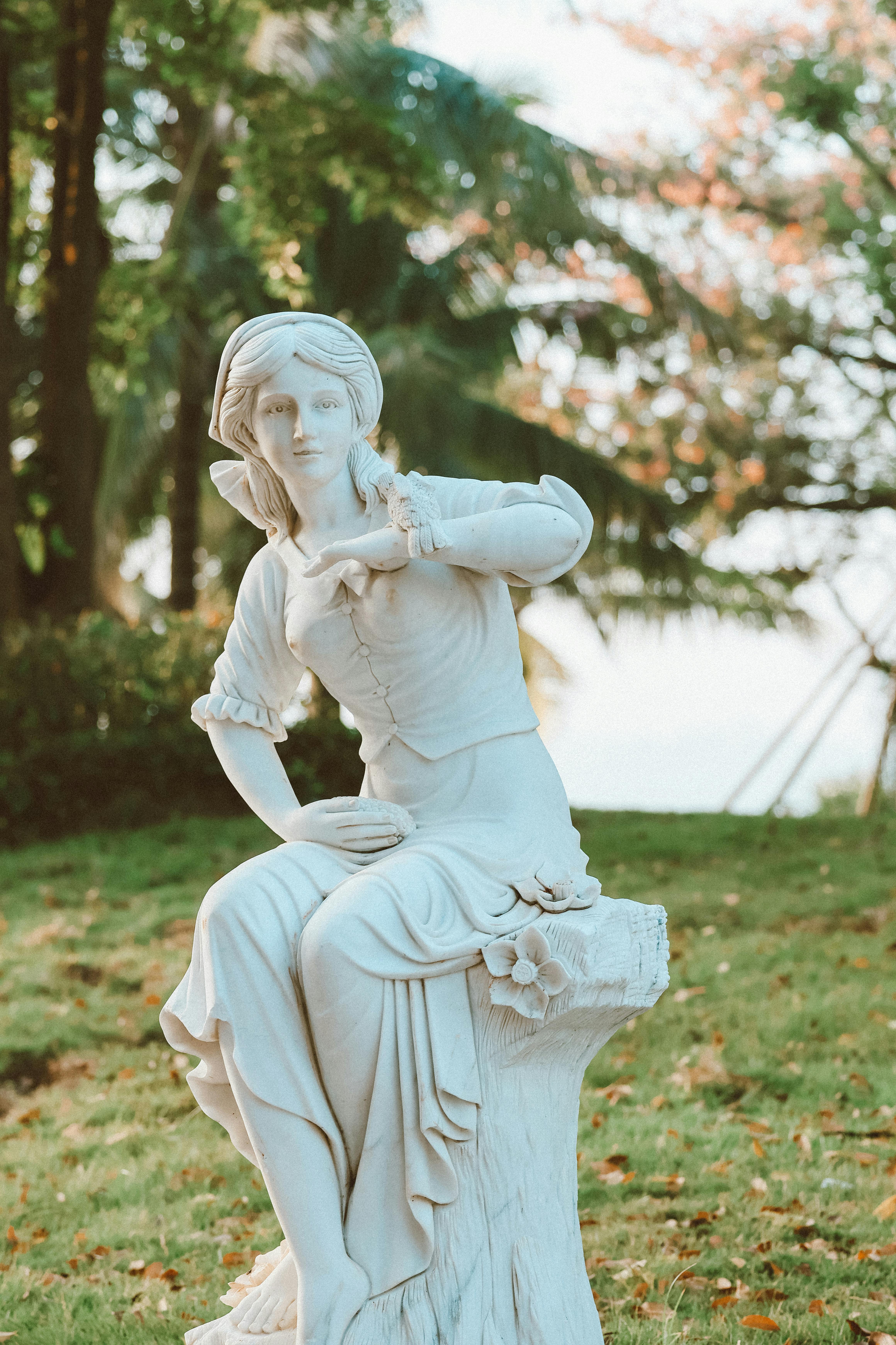Elegant Marble Statue in a Garden Setting · Free Stock Photo