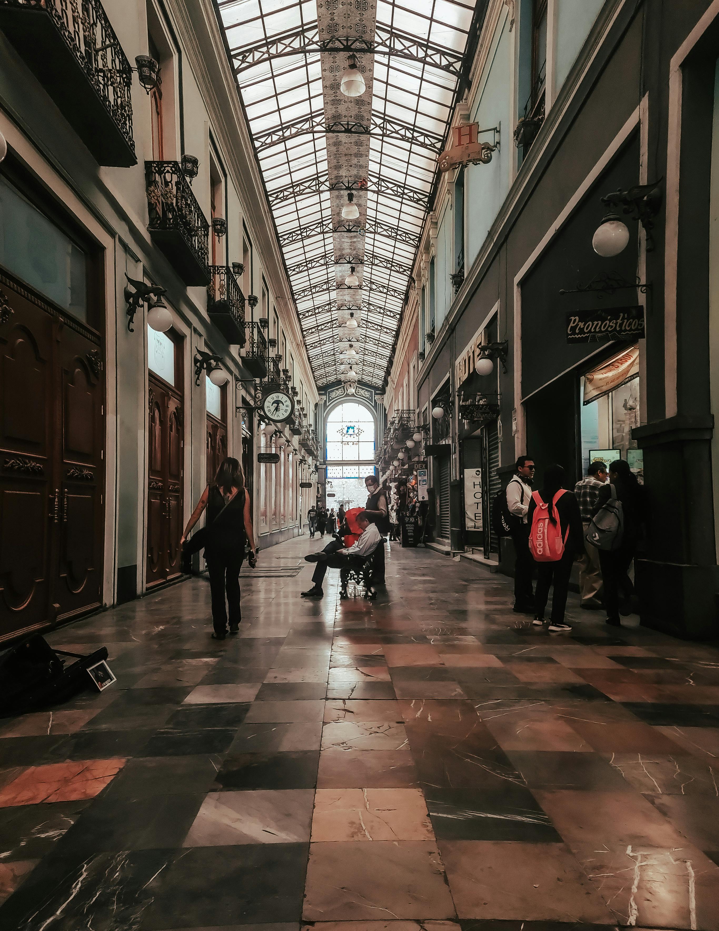 Elegant Indoor Shopping Arcade with People · Free Stock Photo